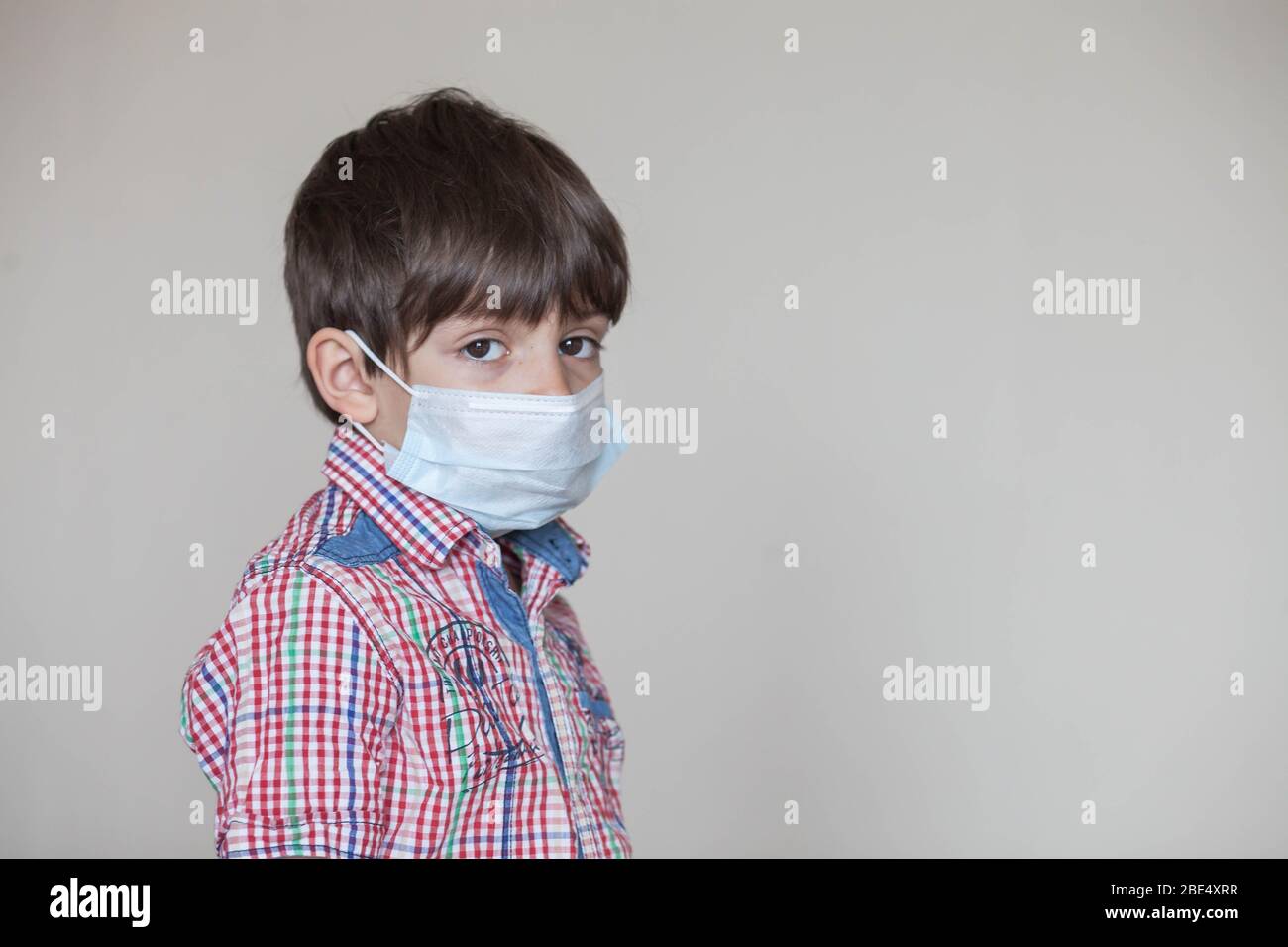 a young boy in a medical mask during the days of the coronavirus ...