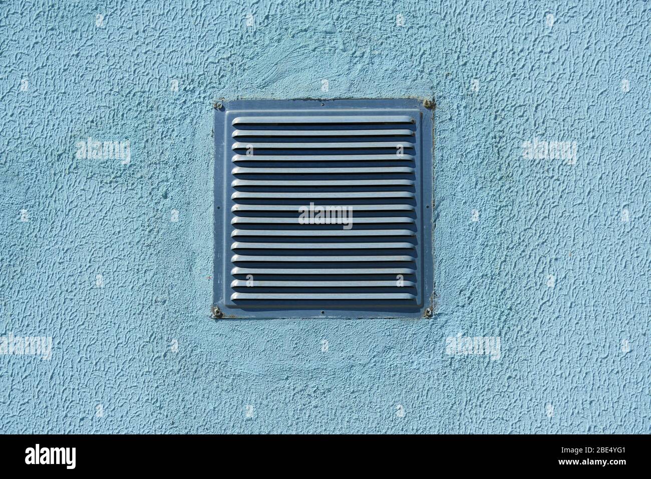 square metal ventilation grate in a blue wall, close view, delivers ...