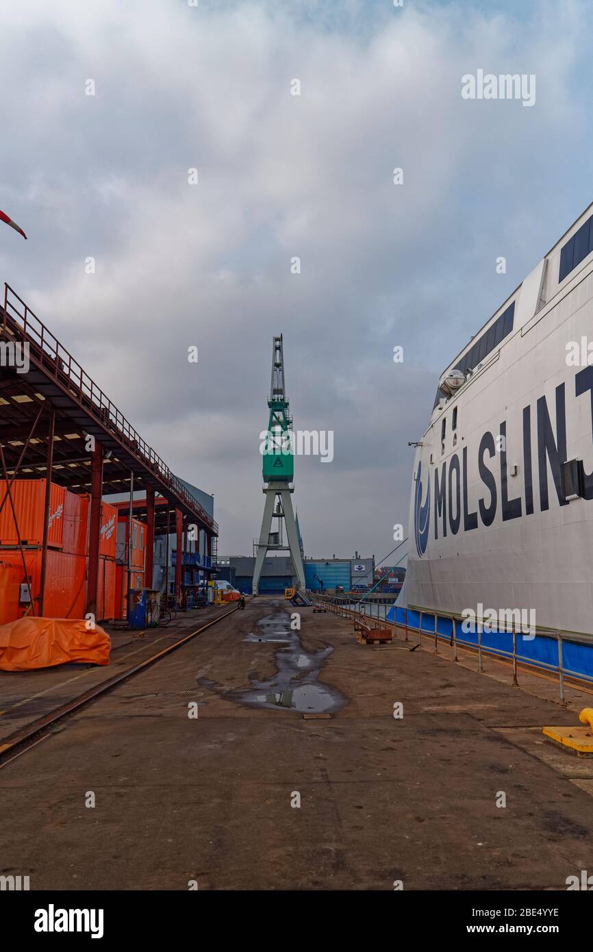 A Shore Crane at the end of a Quay holding a High Speed Catamaran in ...