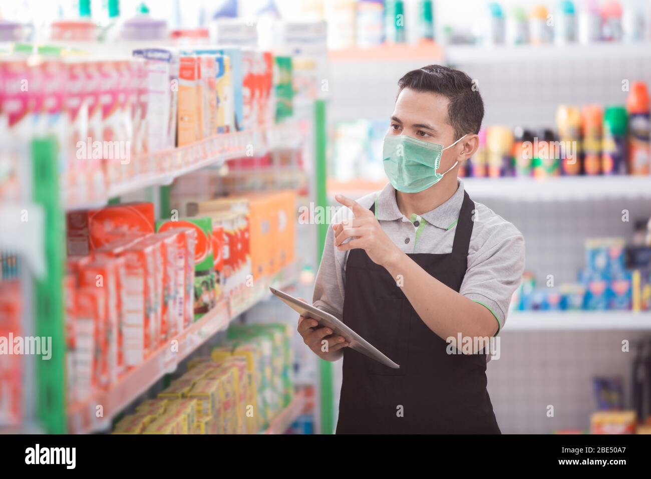 asian male shopkeeper working in a grocery store Stock Photo - Alamy
