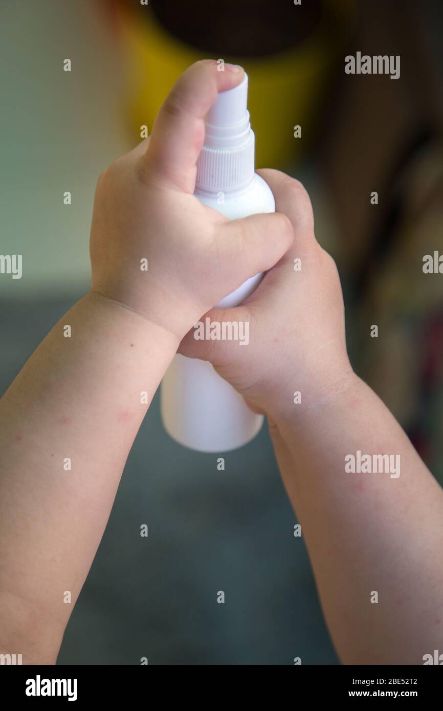 Close up of kid hand holding bottle with antiseptic cleaning gel. Kids ...