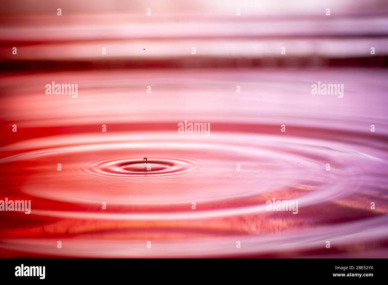 purple splash in to the water Stock Photo - Alamy