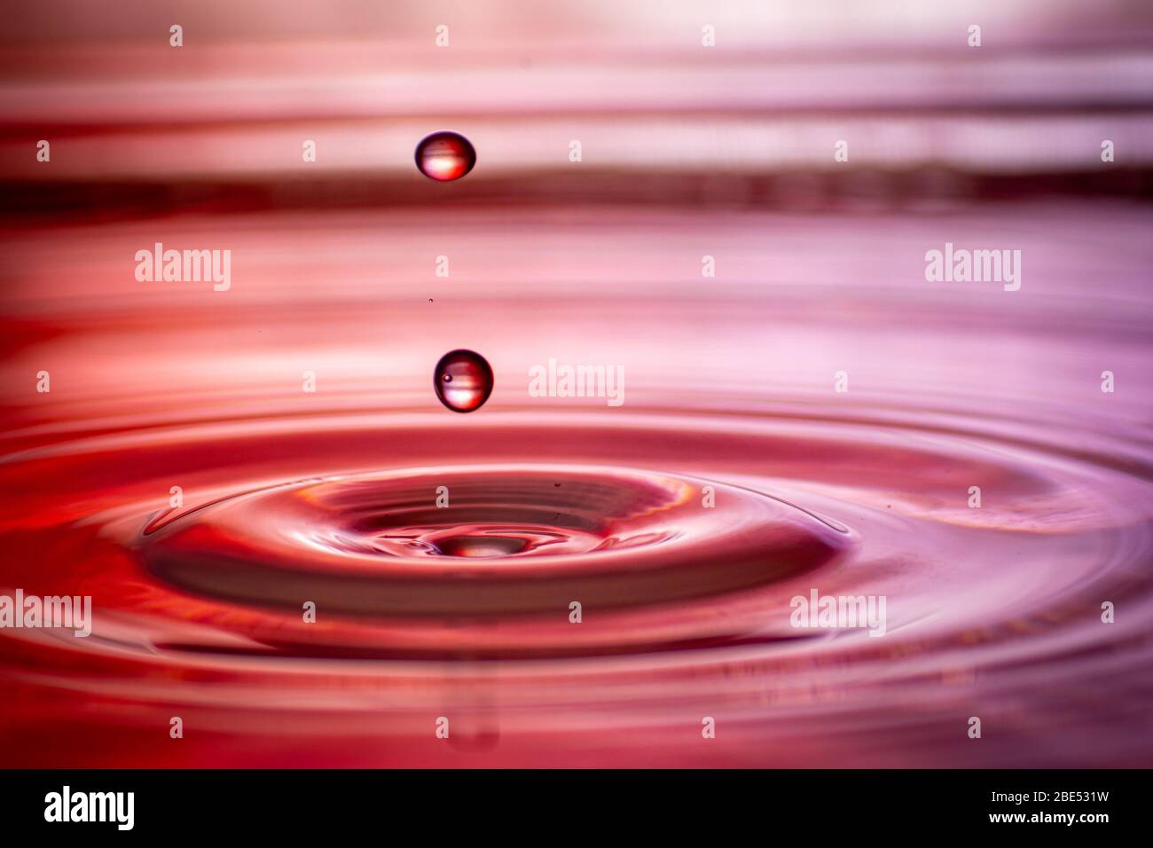 purple splash in to the water Stock Photo - Alamy