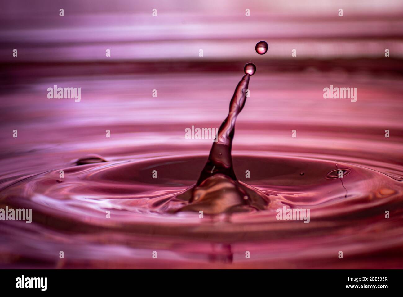 purple splash in to the water Stock Photo - Alamy