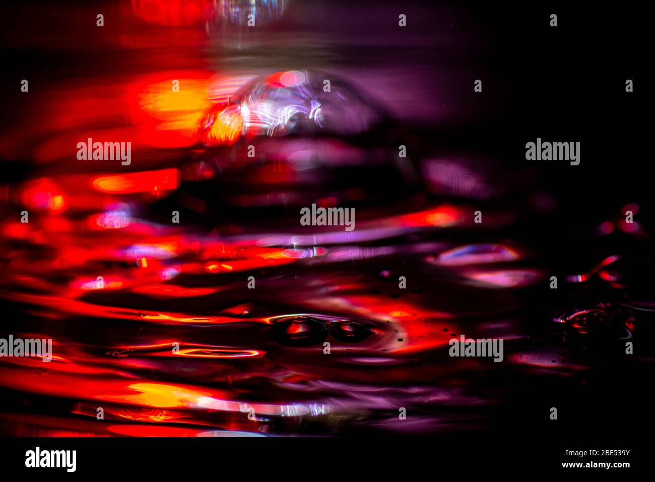 purple splash in to the water Stock Photo - Alamy