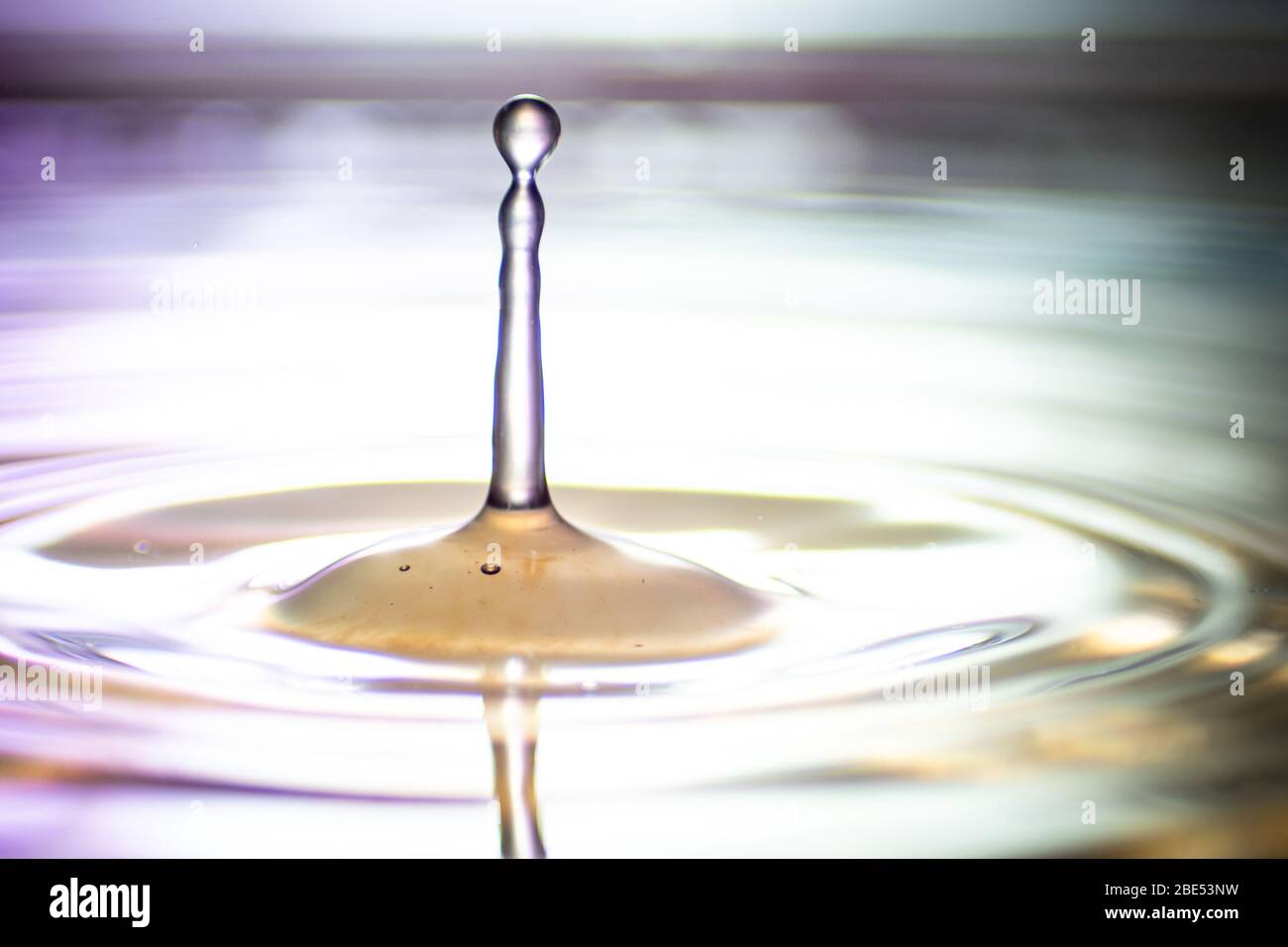 purple splash in to the water Stock Photo - Alamy