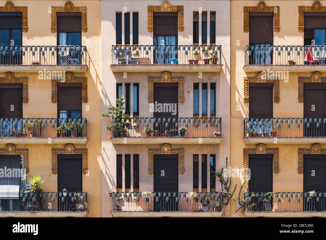 Colored facades and ornamental balconies of a neoclassical building ...