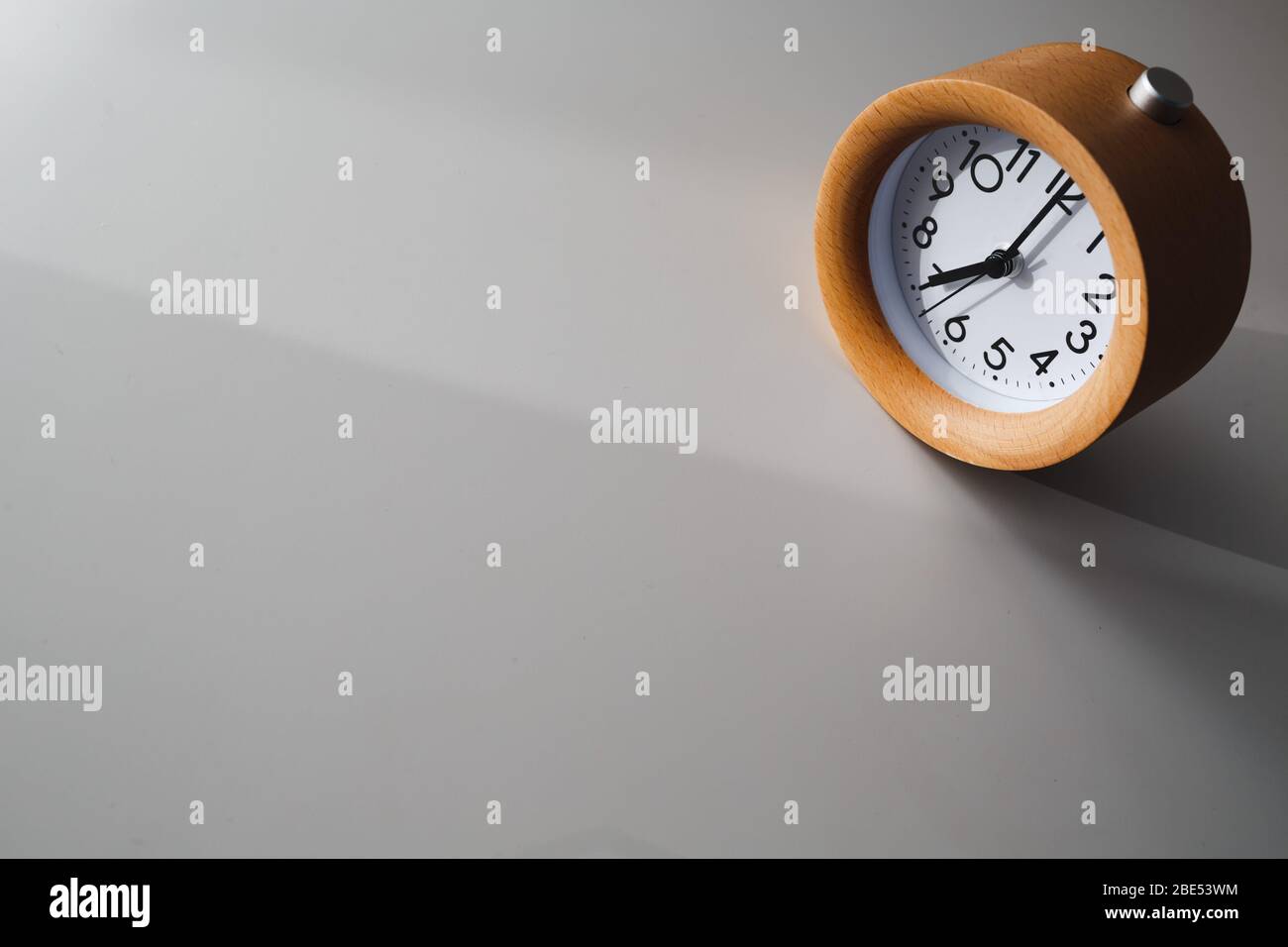 Alarm clock on white table background with empty space Stock Photo - Alamy
