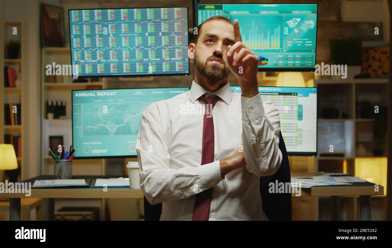 Male stock market trader using augmented reality in home office ...