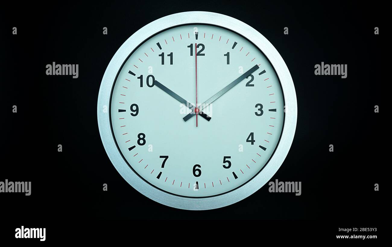 White clock face beginning of time 10.09 am or pm. on black background ...