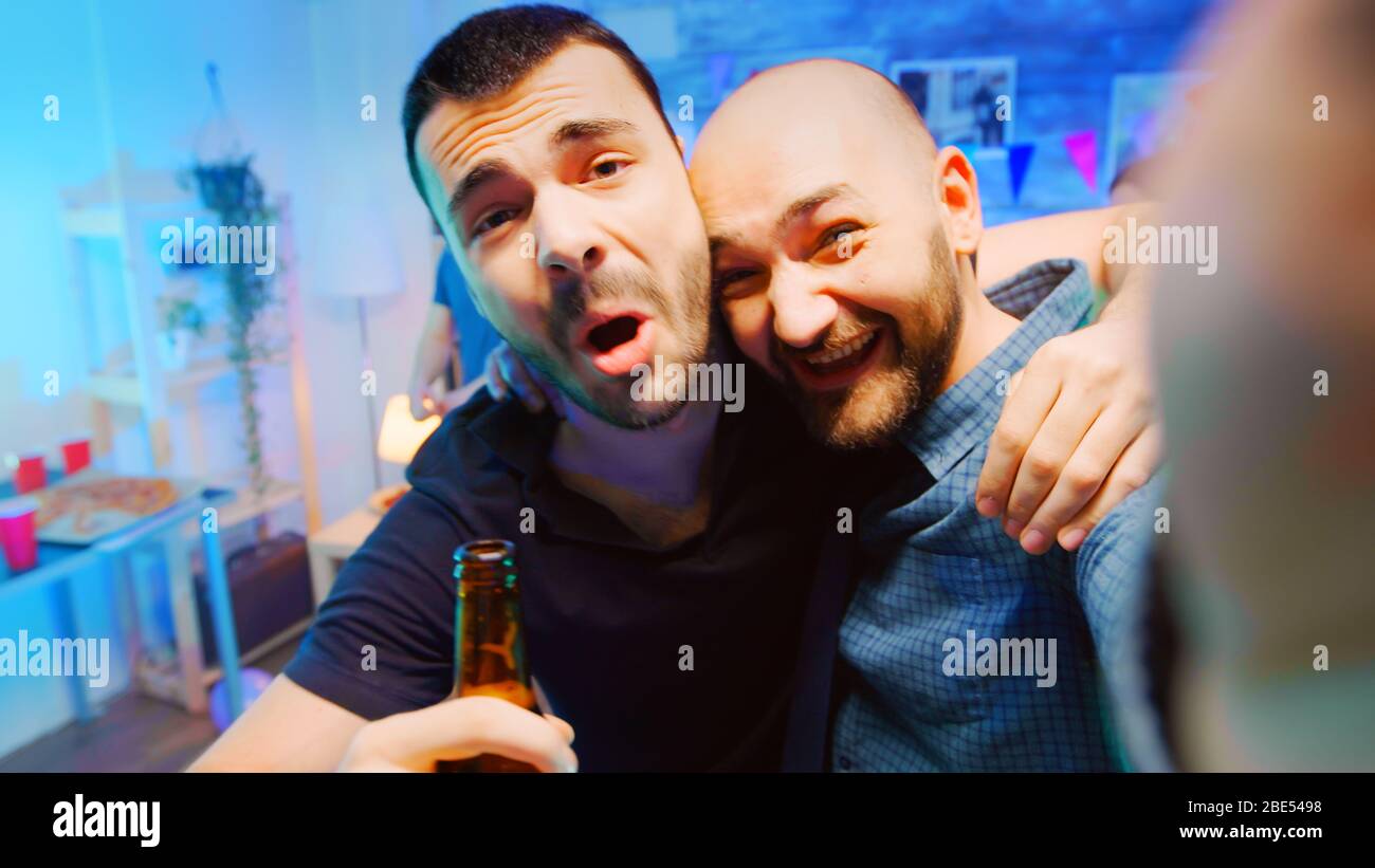 Pov young man inviting people at the party in his home. Neon lights ...