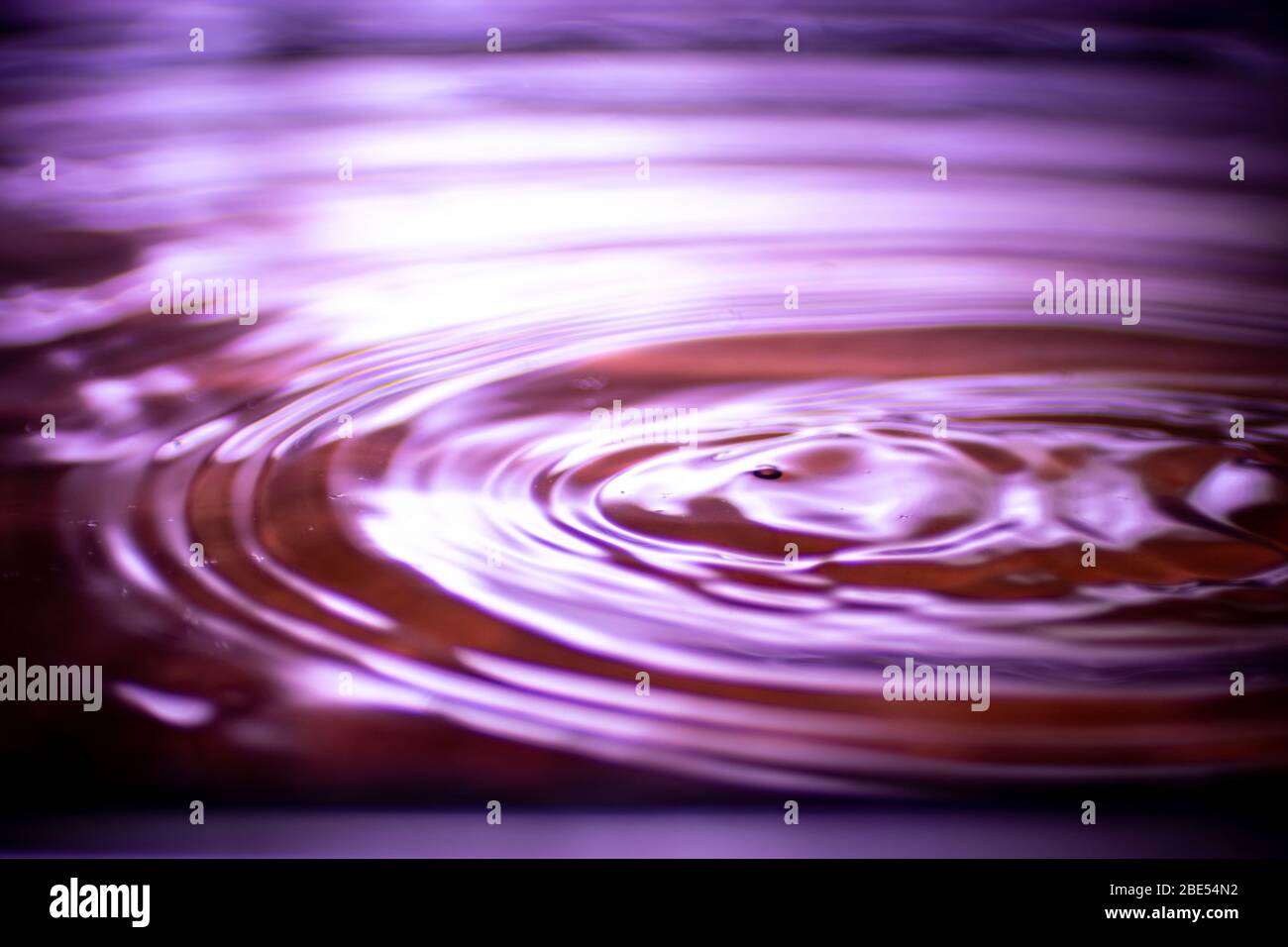 purple splash in to the water Stock Photo - Alamy