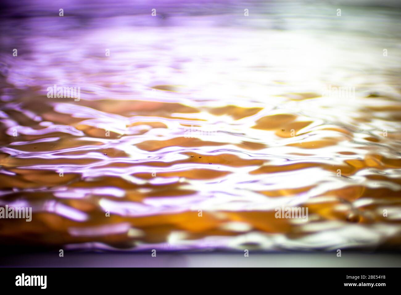 purple splash in to the water Stock Photo - Alamy