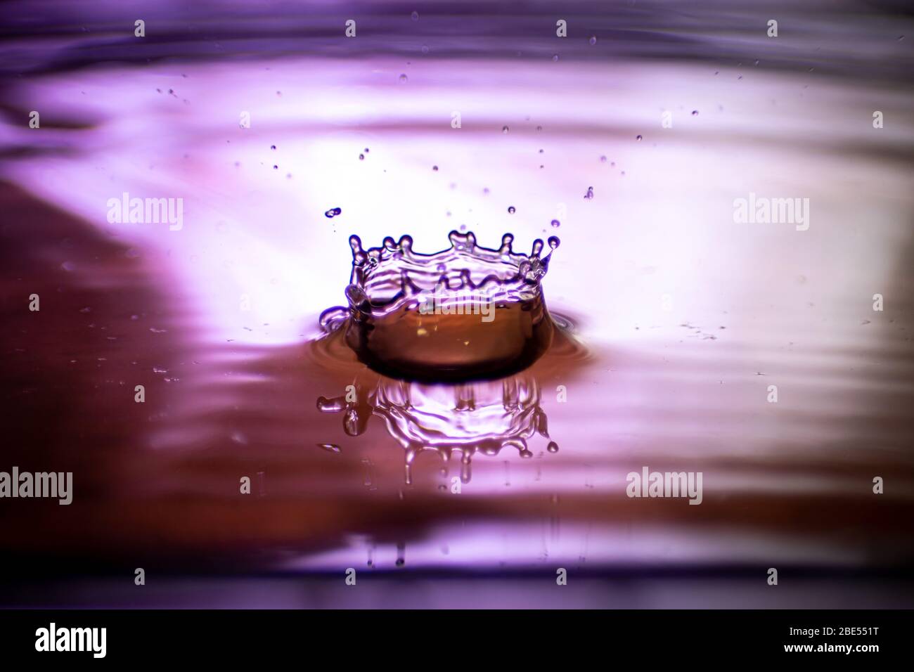 purple splash in to the water Stock Photo - Alamy