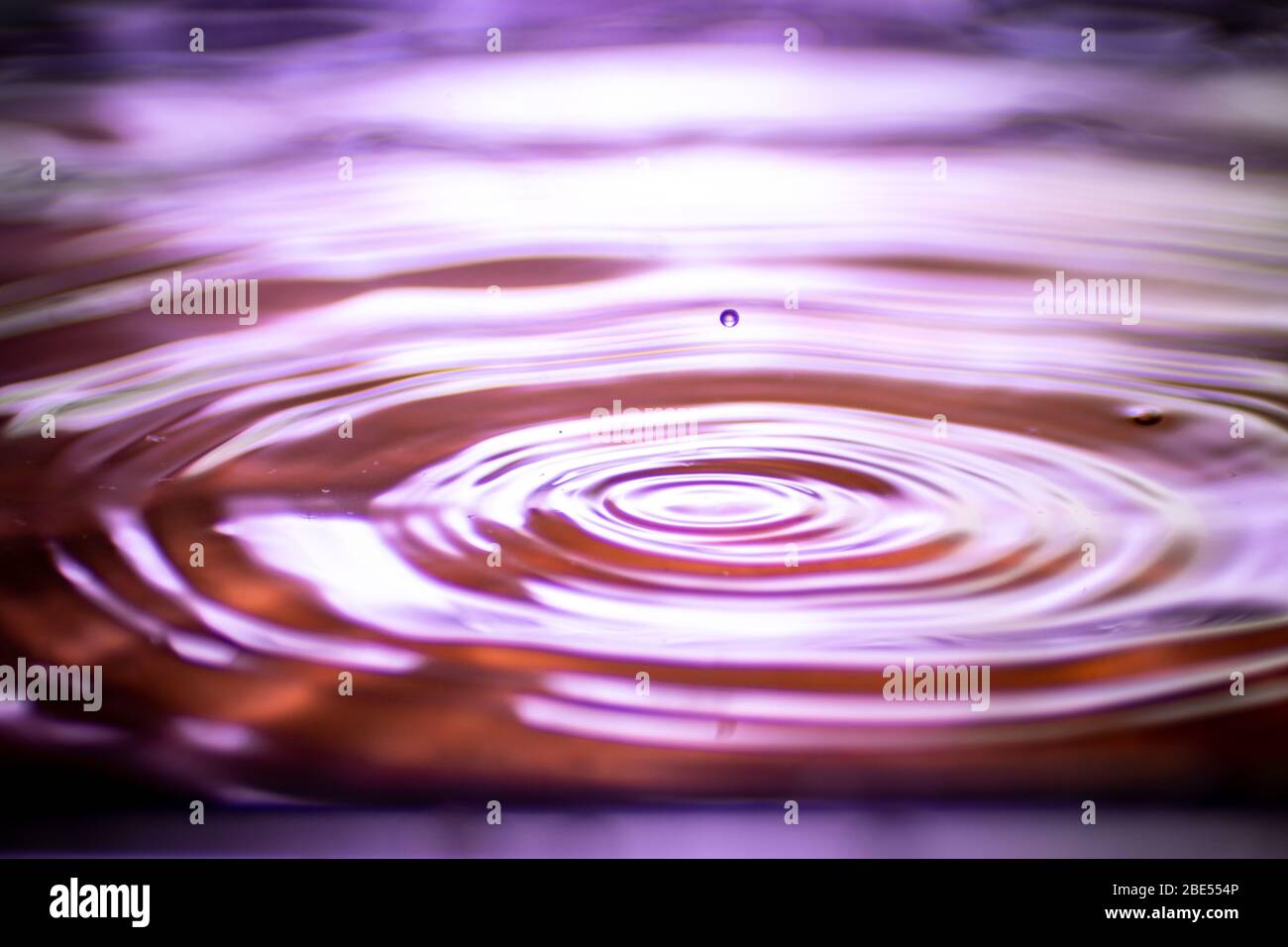 purple splash in to the water Stock Photo - Alamy