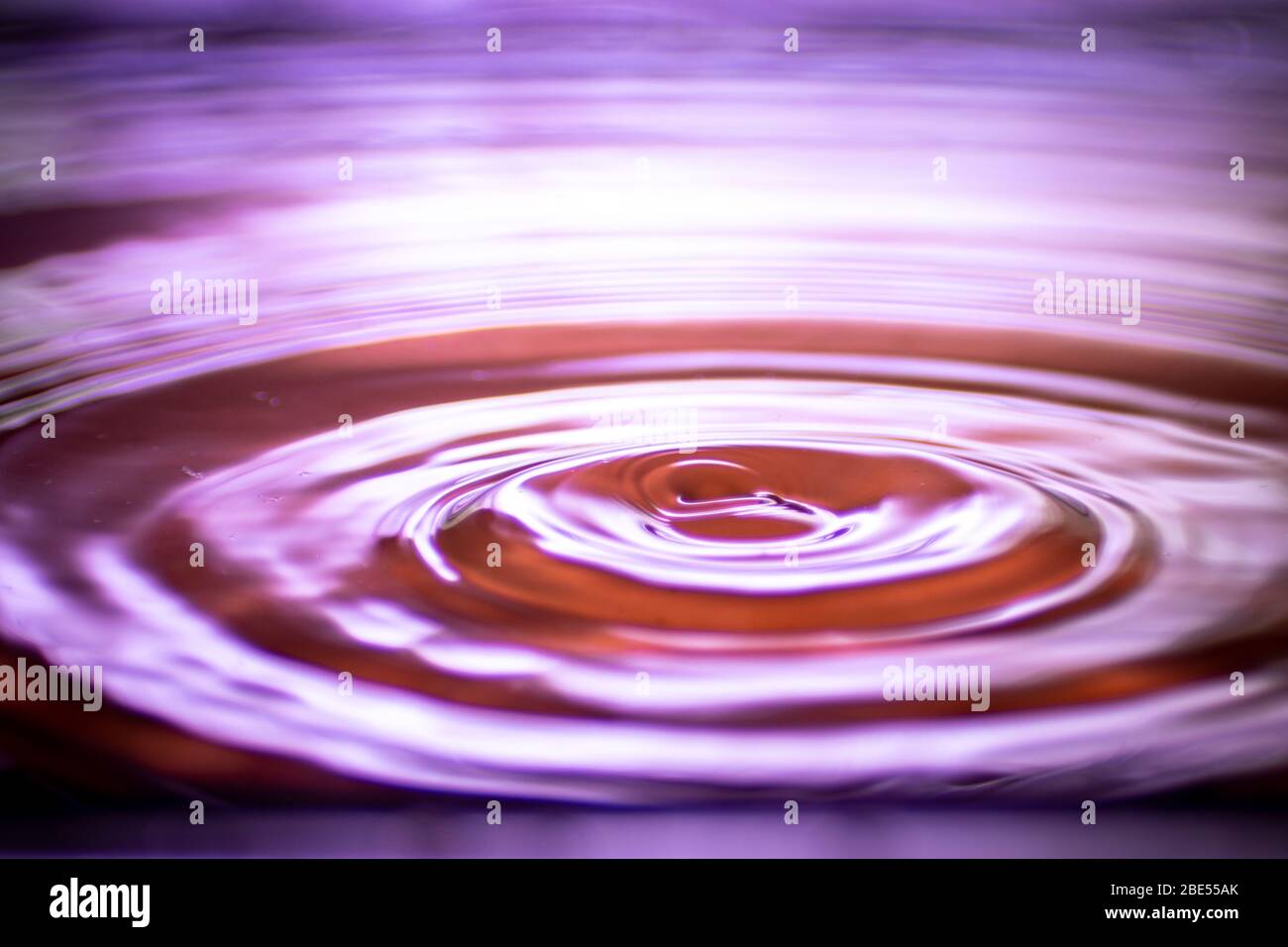 purple splash in to the water Stock Photo - Alamy