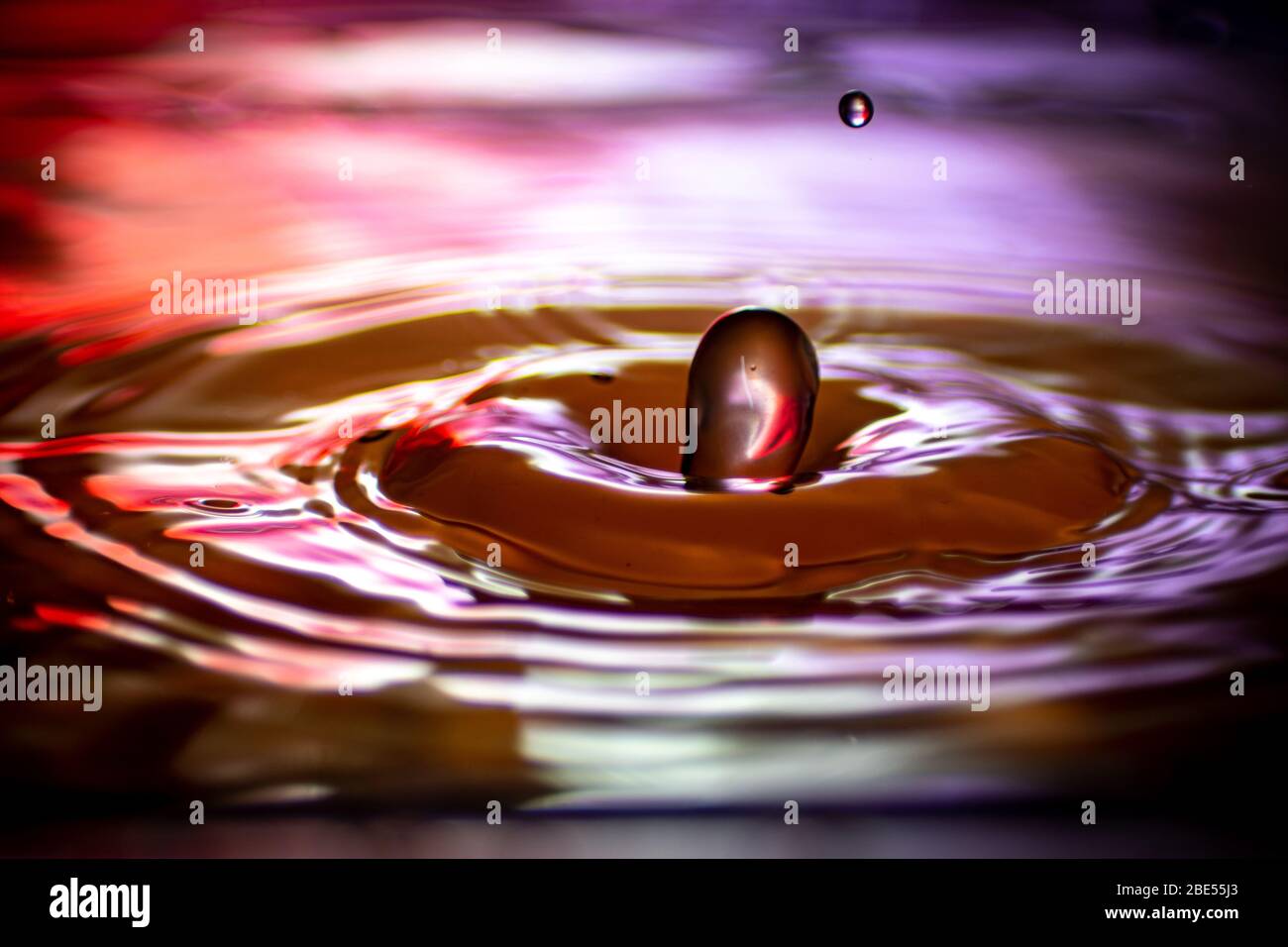 purple splash in to the water Stock Photo - Alamy