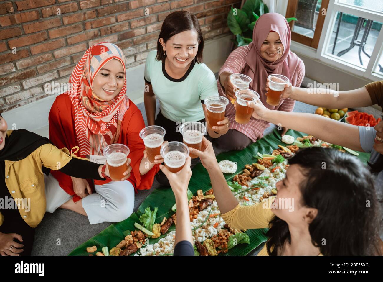 tea time with friend during lunch. muslim asian woman with friends ...