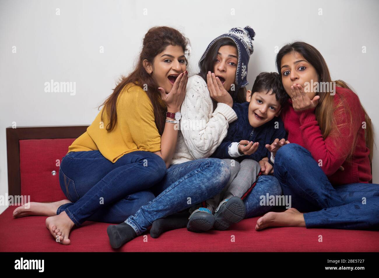 Sisters having fun with their little nephew at home Stock Photo - Alamy