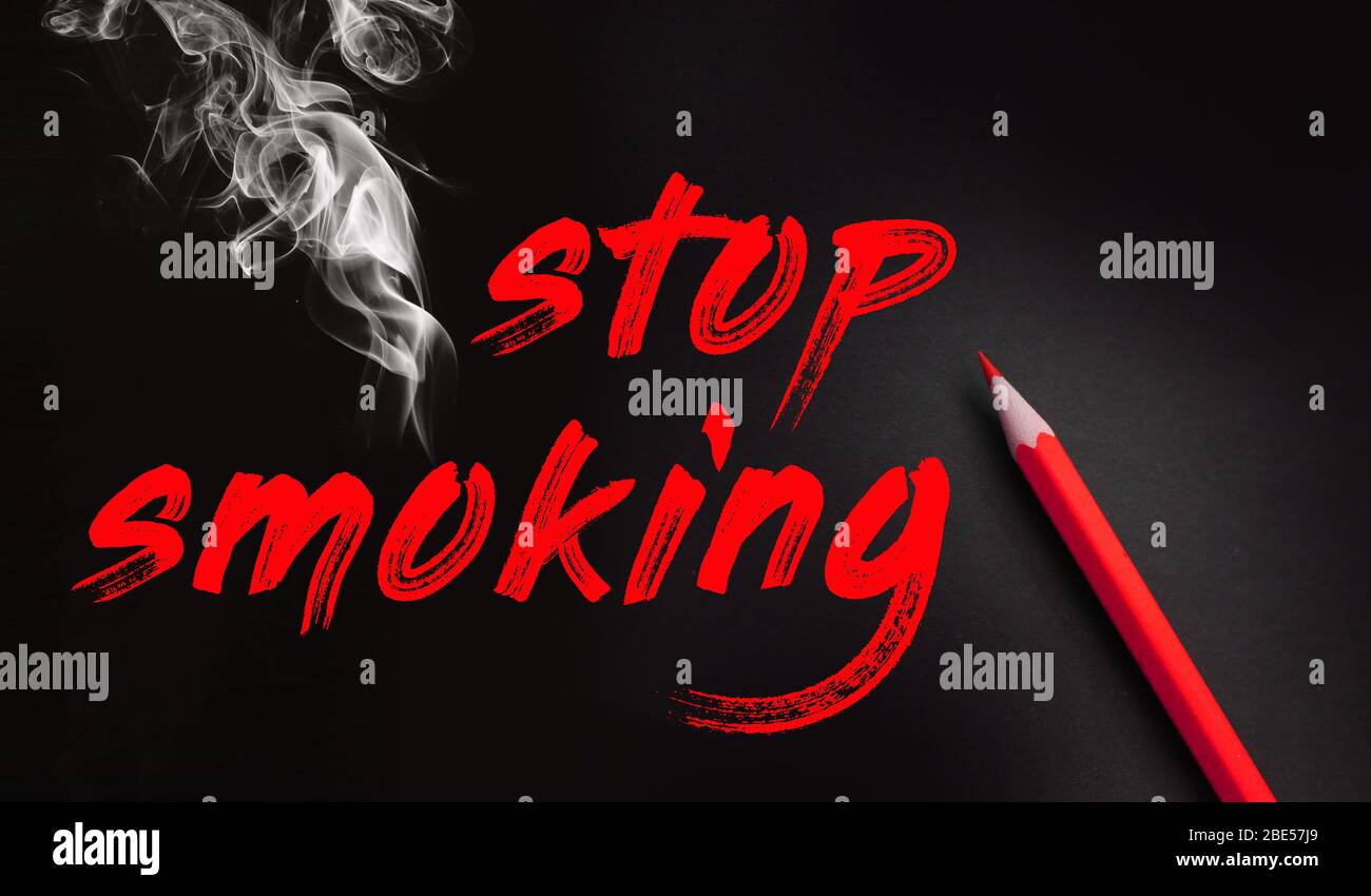 Stop smoking words, red pencil and smoke on black background. No ...