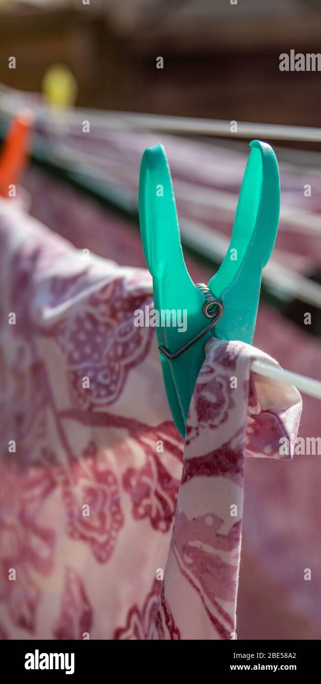 clothes peg holding up washing on a line on a hot spring or summer day ...