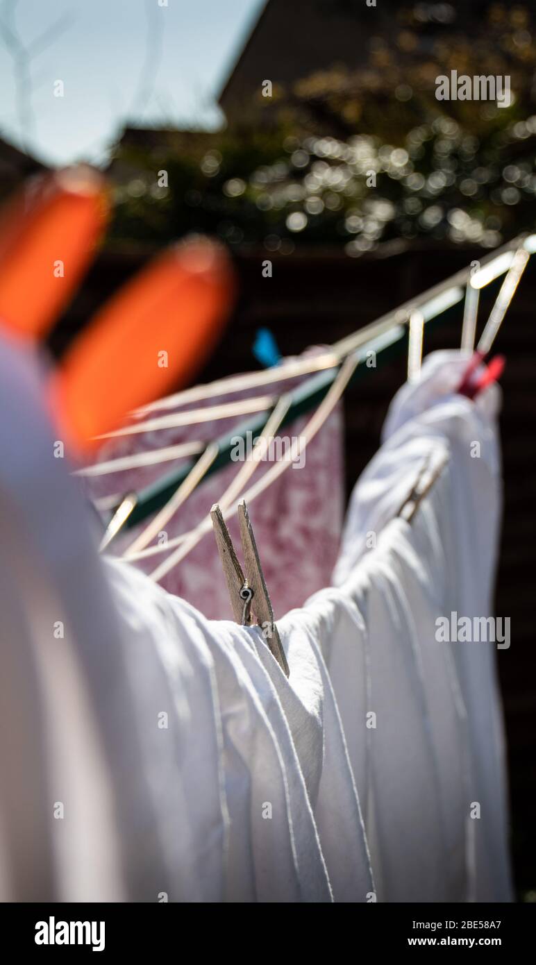 clothes peg holding up washing on a line on a hot spring or summer day ...