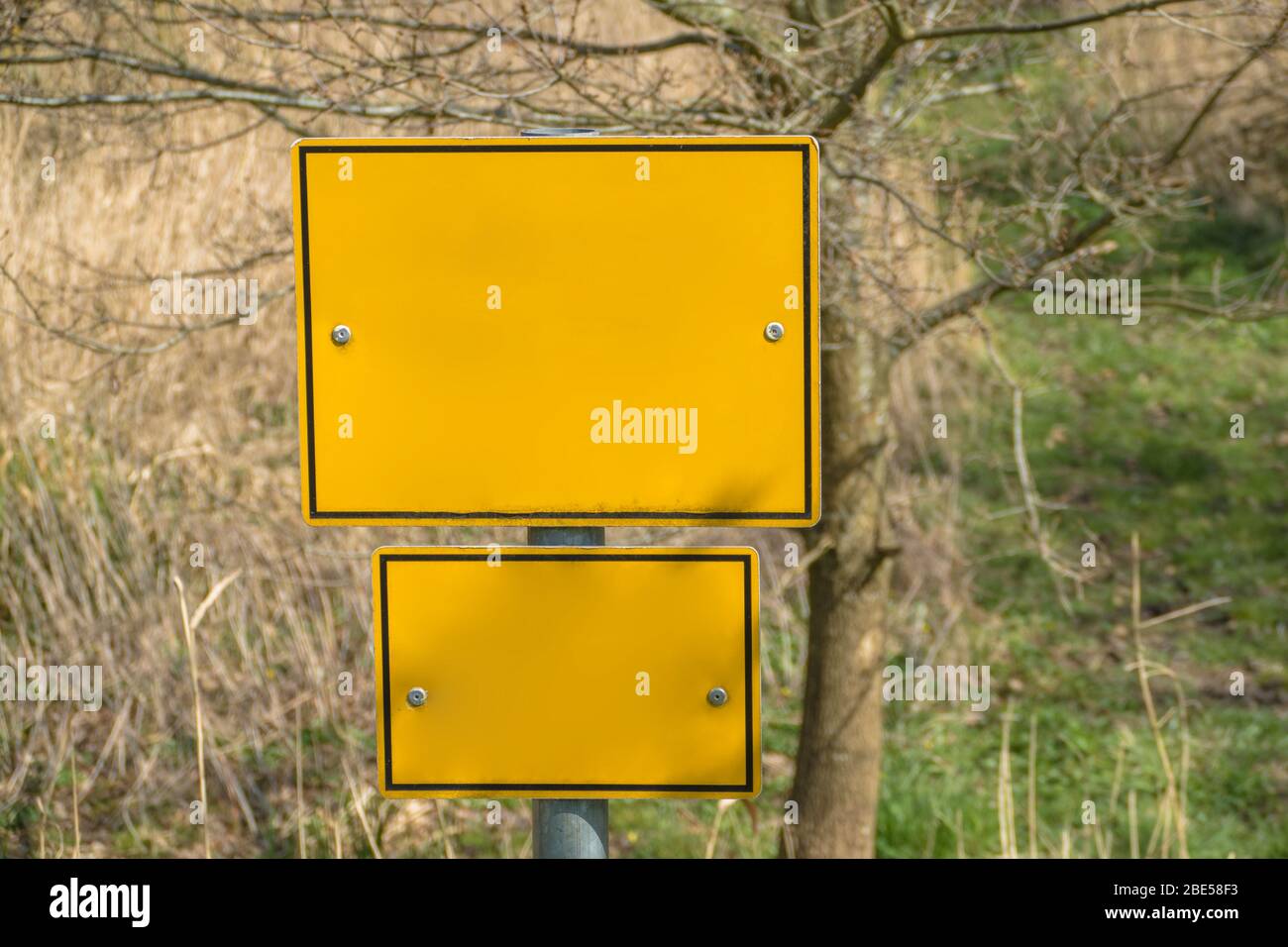 Blank yellow board giving warning message Stock Photo - Alamy