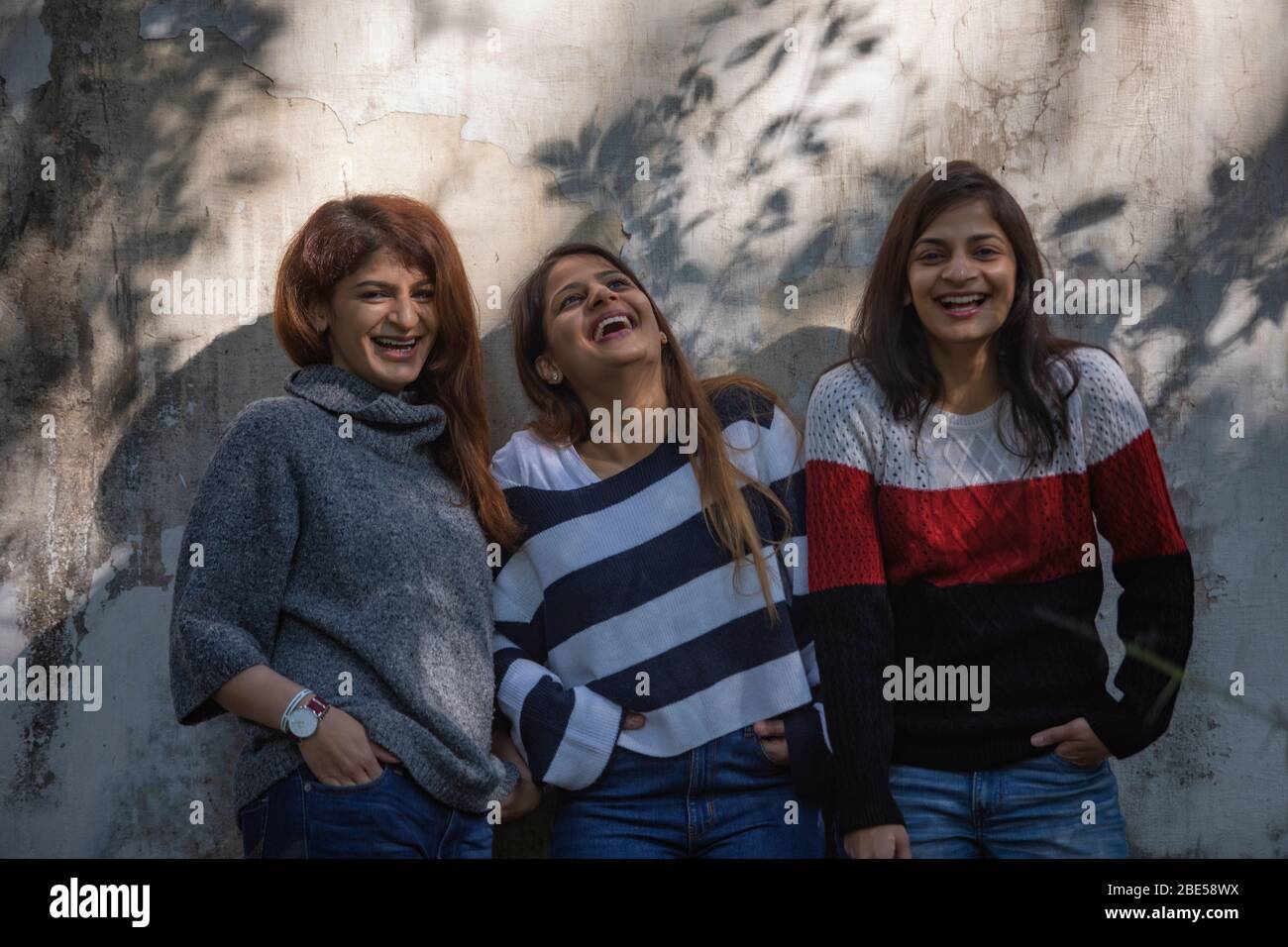 Sisters laughing together outside in the sun Stock Photo - Alamy