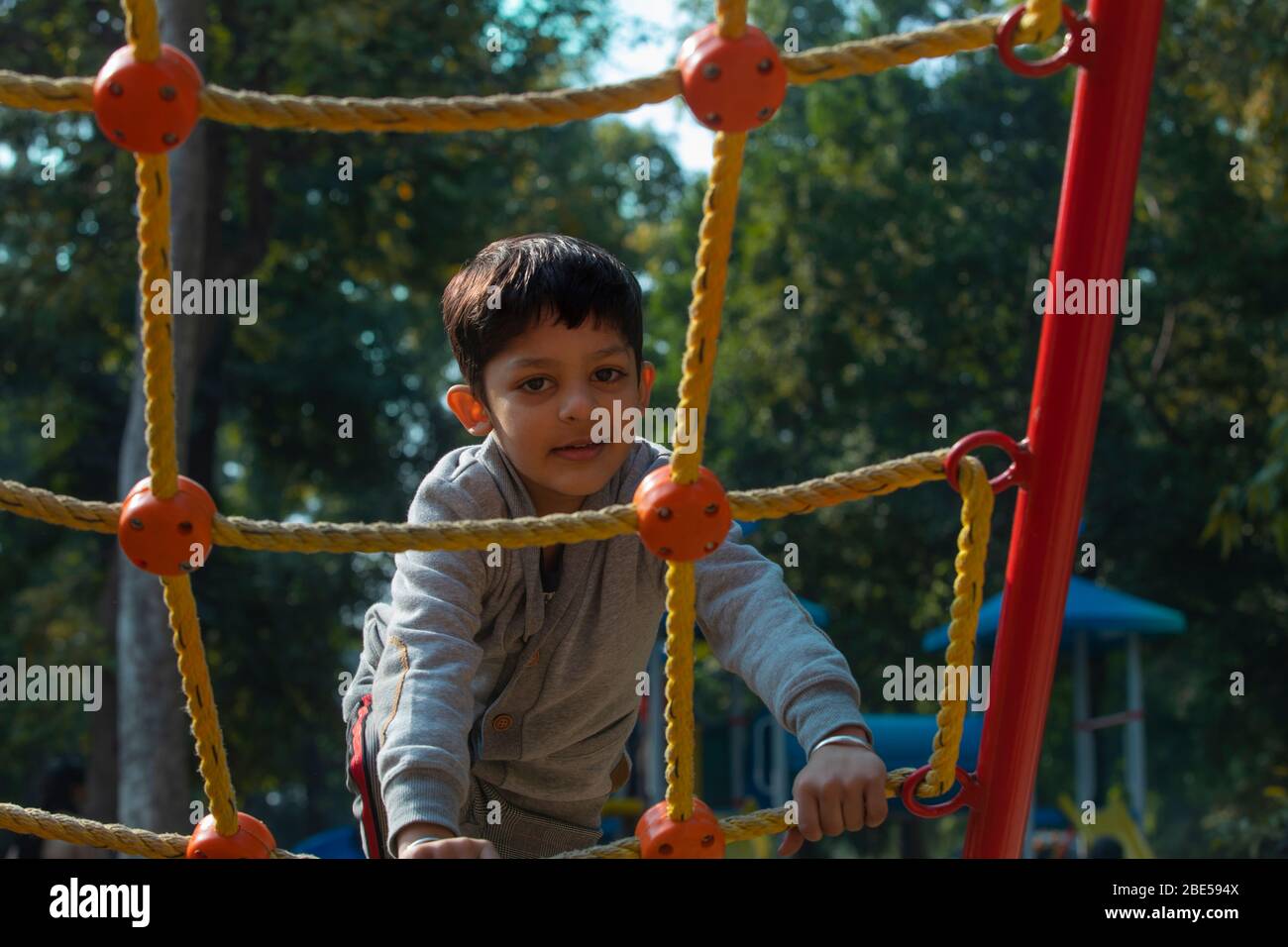 Young boy climbing ropes in the park. (Children Stock Photo - Alamy
