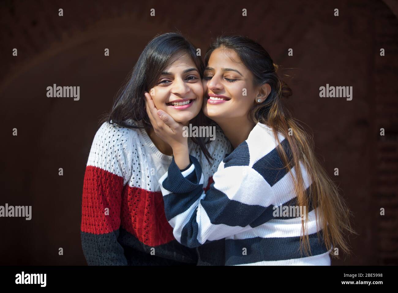Sisters showing love to each other Stock Photo - Alamy