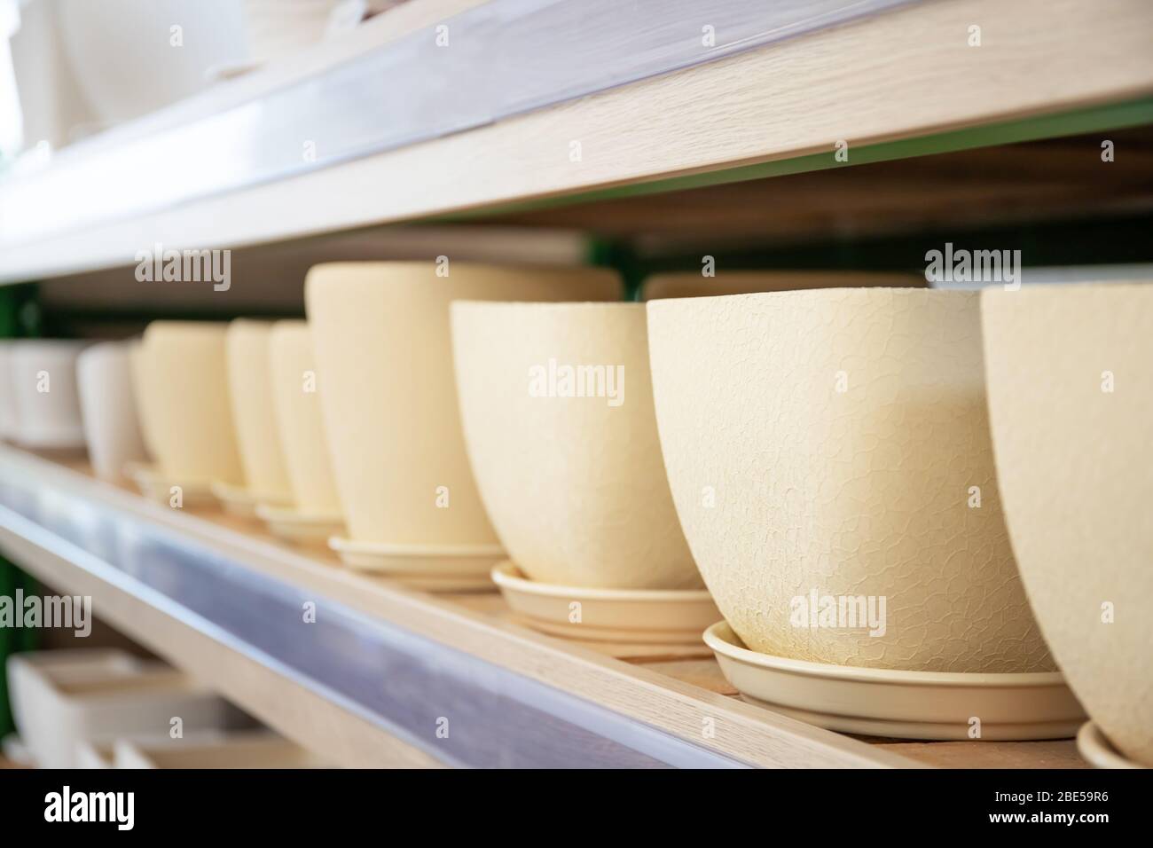Ceramic flower pots on a rack in a store. gardening Tools Stock Photo ...