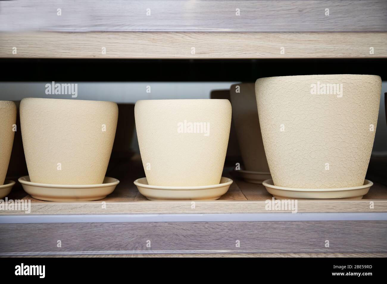 Ceramic flower pots on a rack in a store. gardening Tools Stock Photo ...