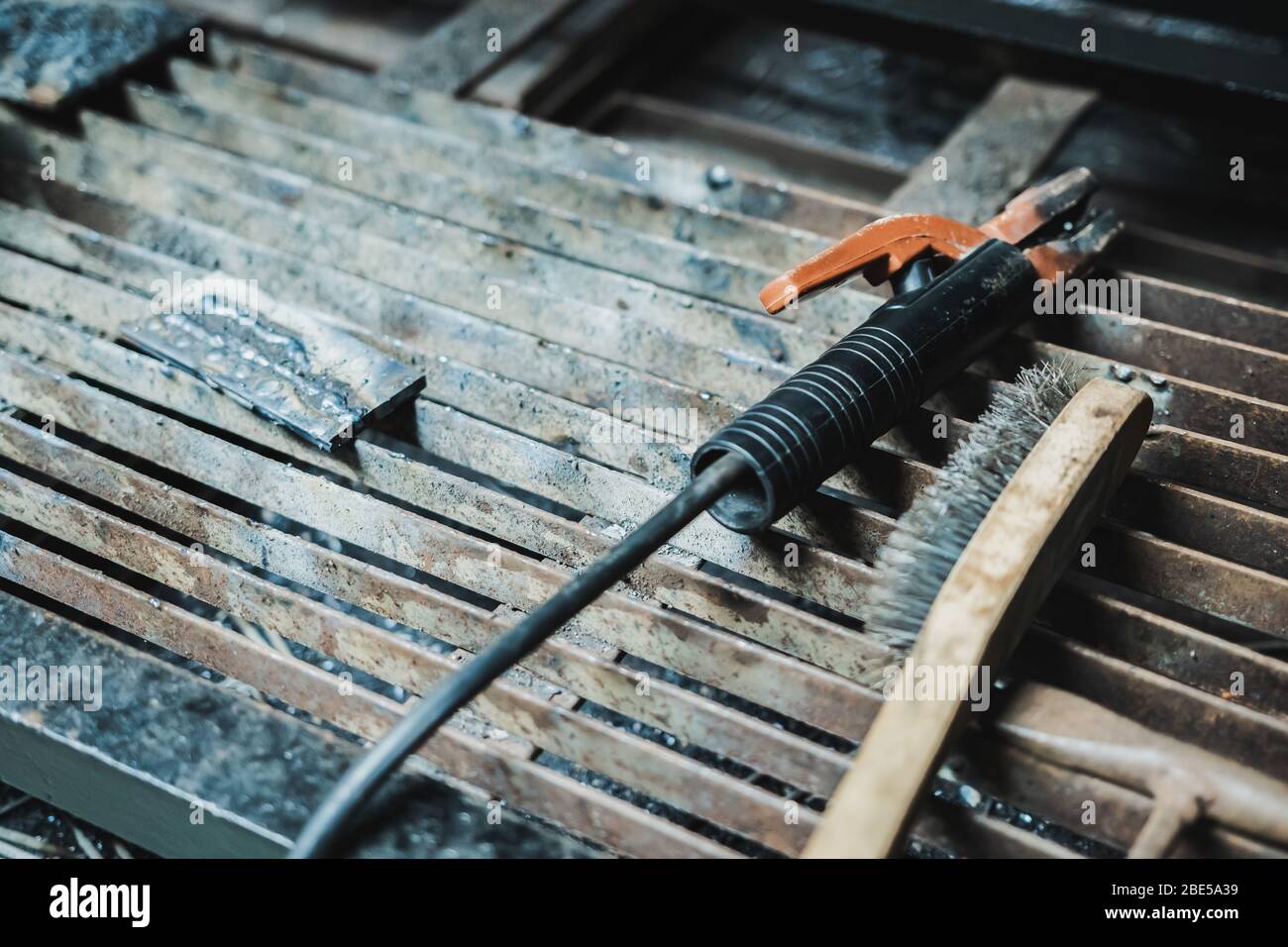Electric metal welding workbench with electrode and steel brush placed ...