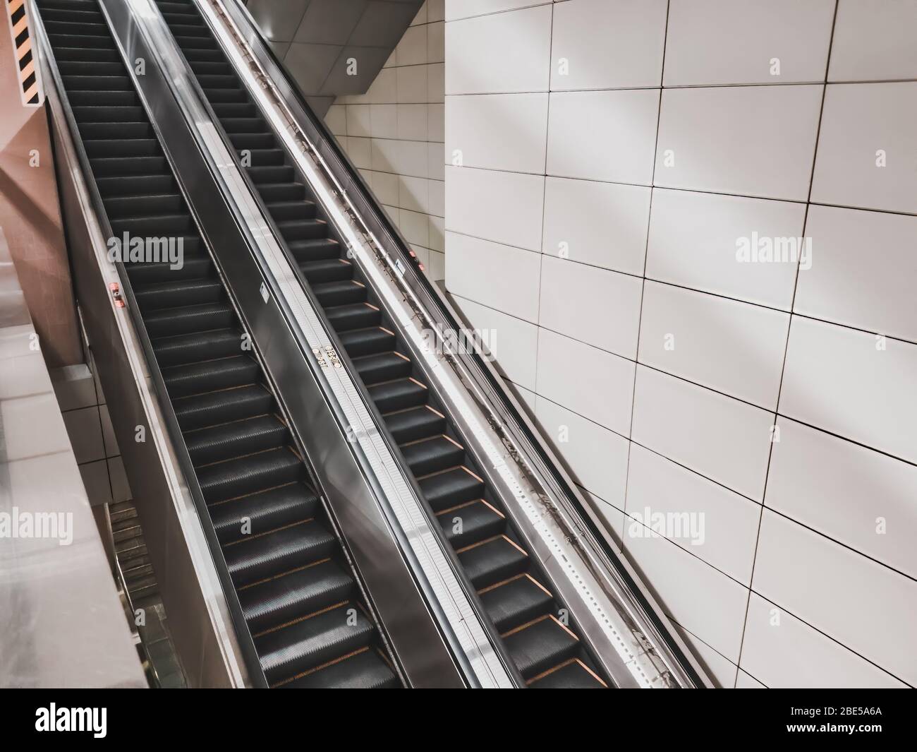 Long escalator to deep underground subway station in urban area or ...