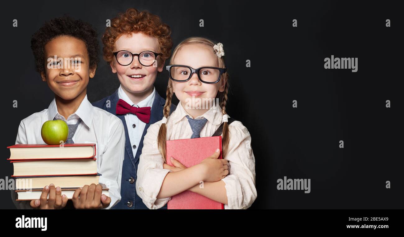 Smiling kids student on blackboard background. Happy school children ...