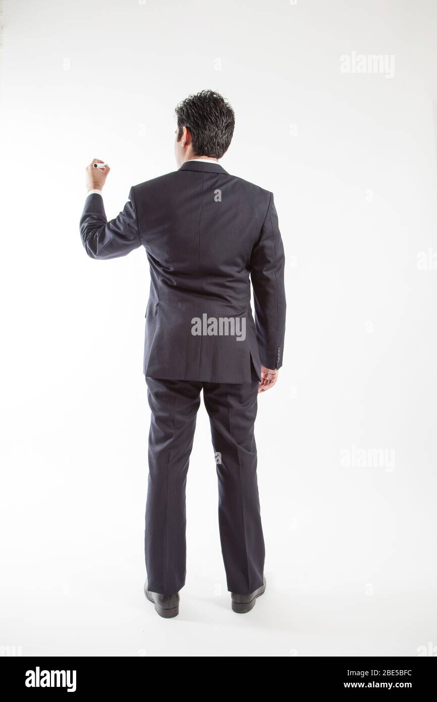 Business man wearing suit pretends to write on screen camera holding ...