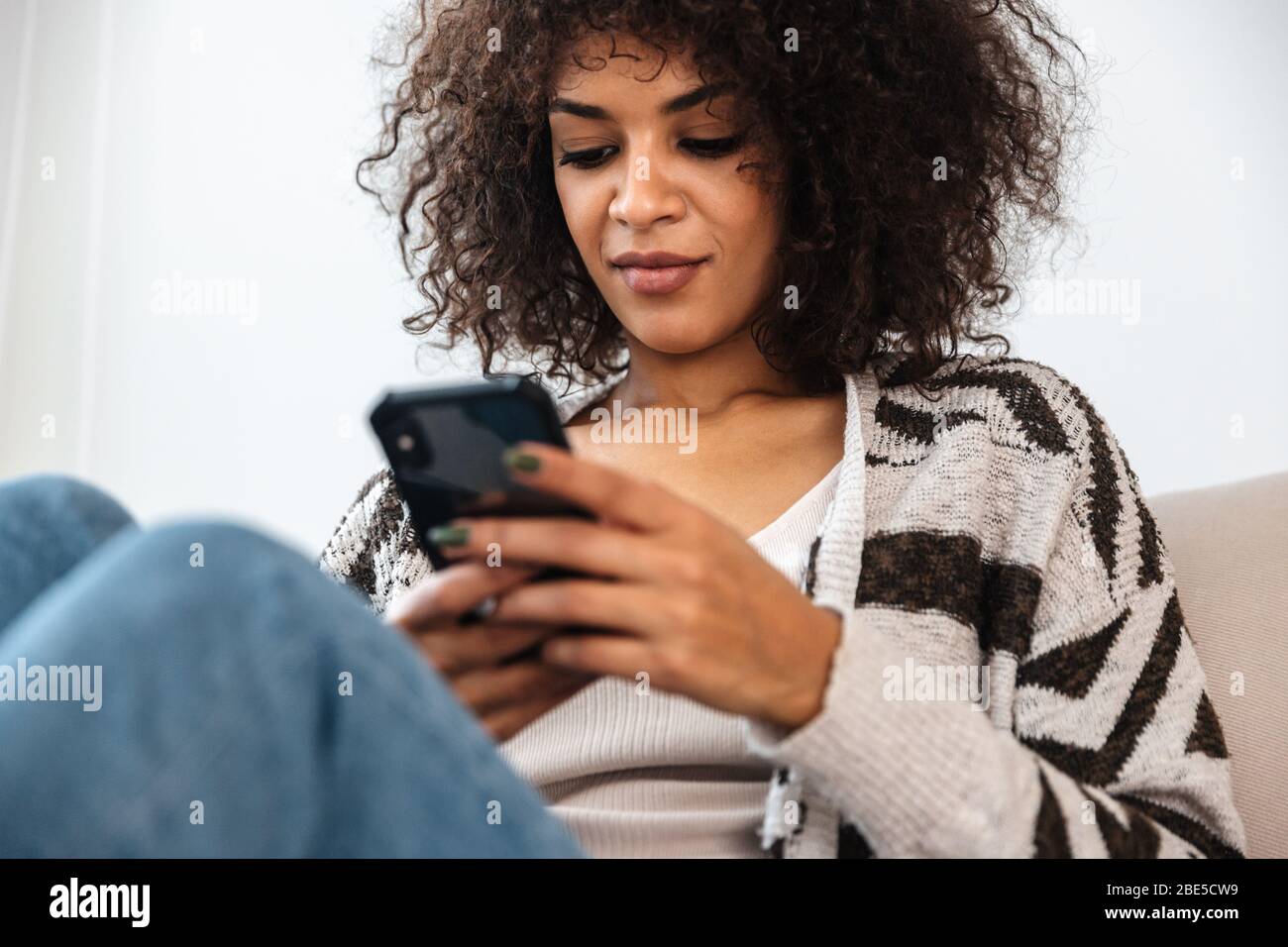 Image Of Positive Optimistic Young African Woman Indoors At Home Using