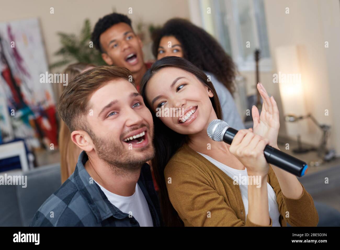 Best Friends Singing Young Happy Couple Or Friends Holding Microphone