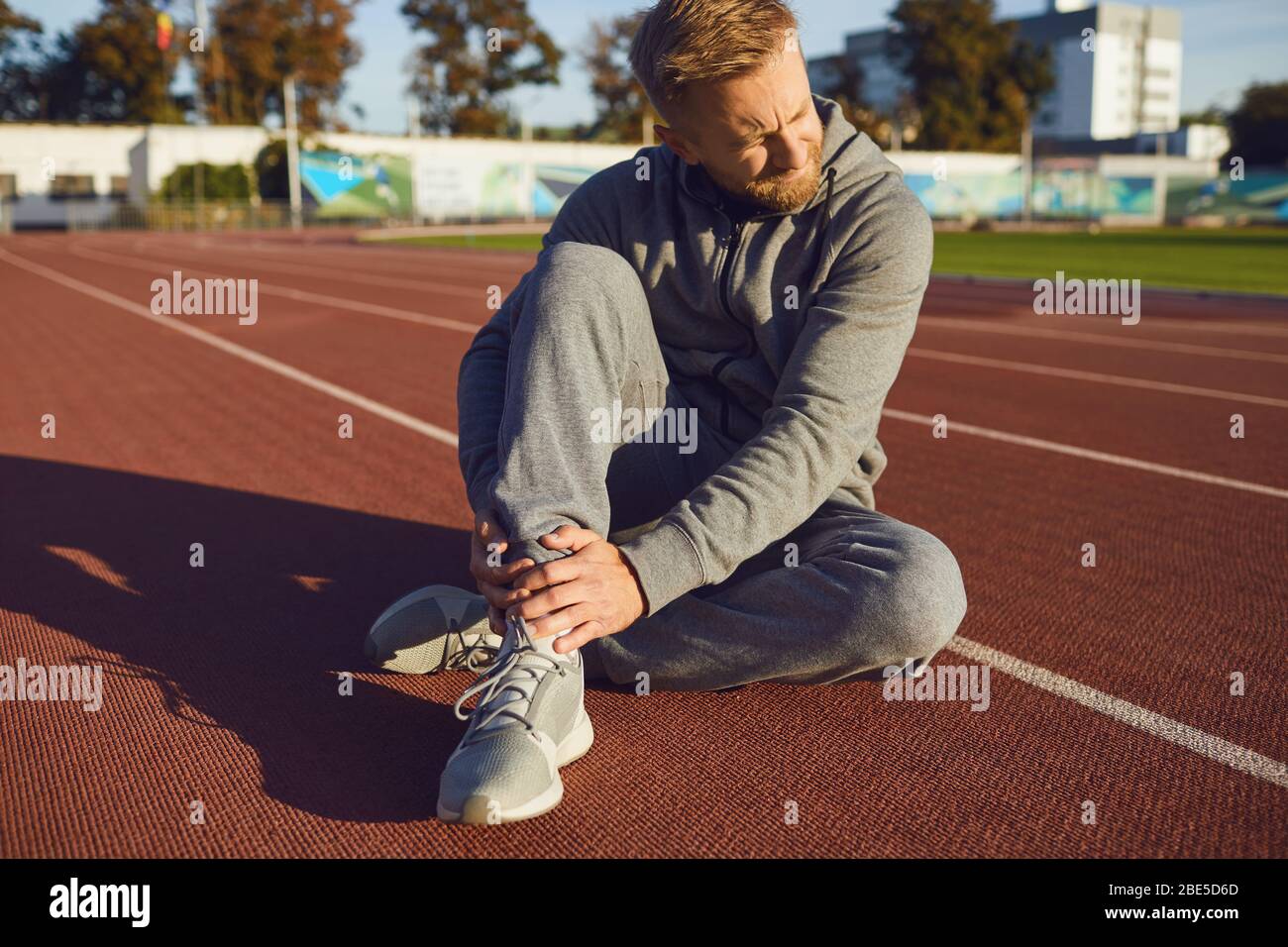 Knee injury in training. Man injured his leg during exercise. Injury ...