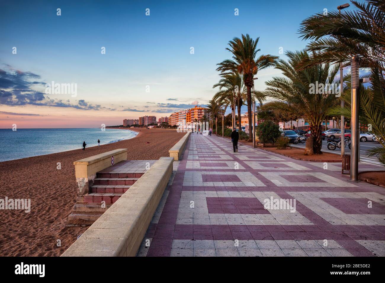 Promenade along the sea and beach in Blanes town at dawn, Costa Brava ...