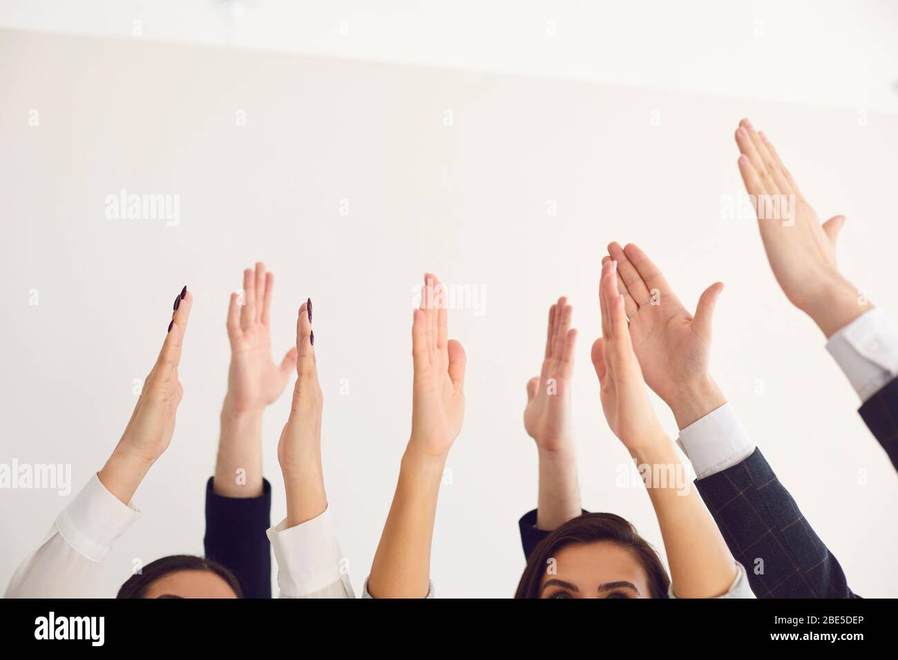 Hands up. Hands of a group of people on a white background Stock Photo ...