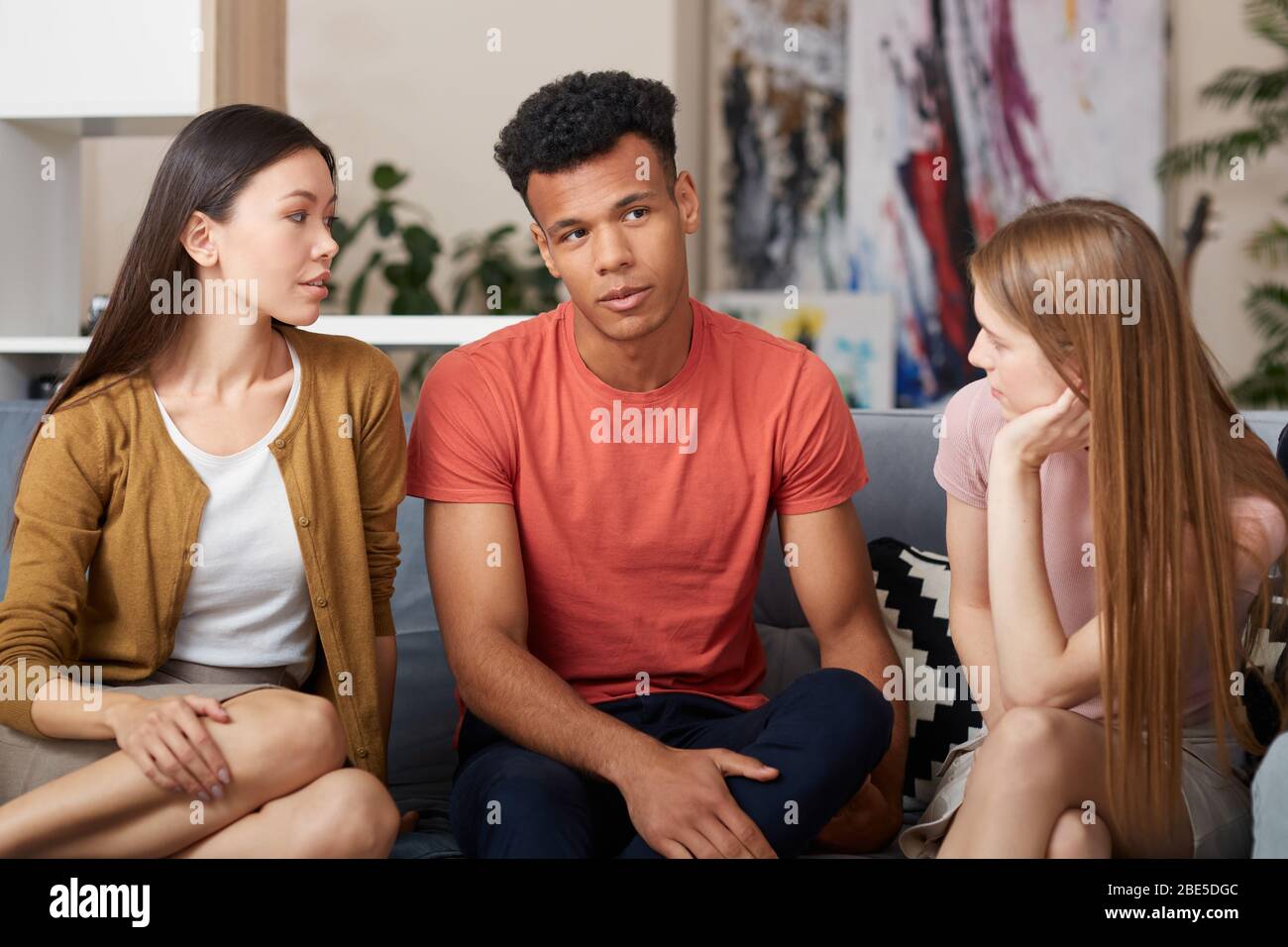 Friendly talk. Young multicultural friends in casual wear chatting and ...