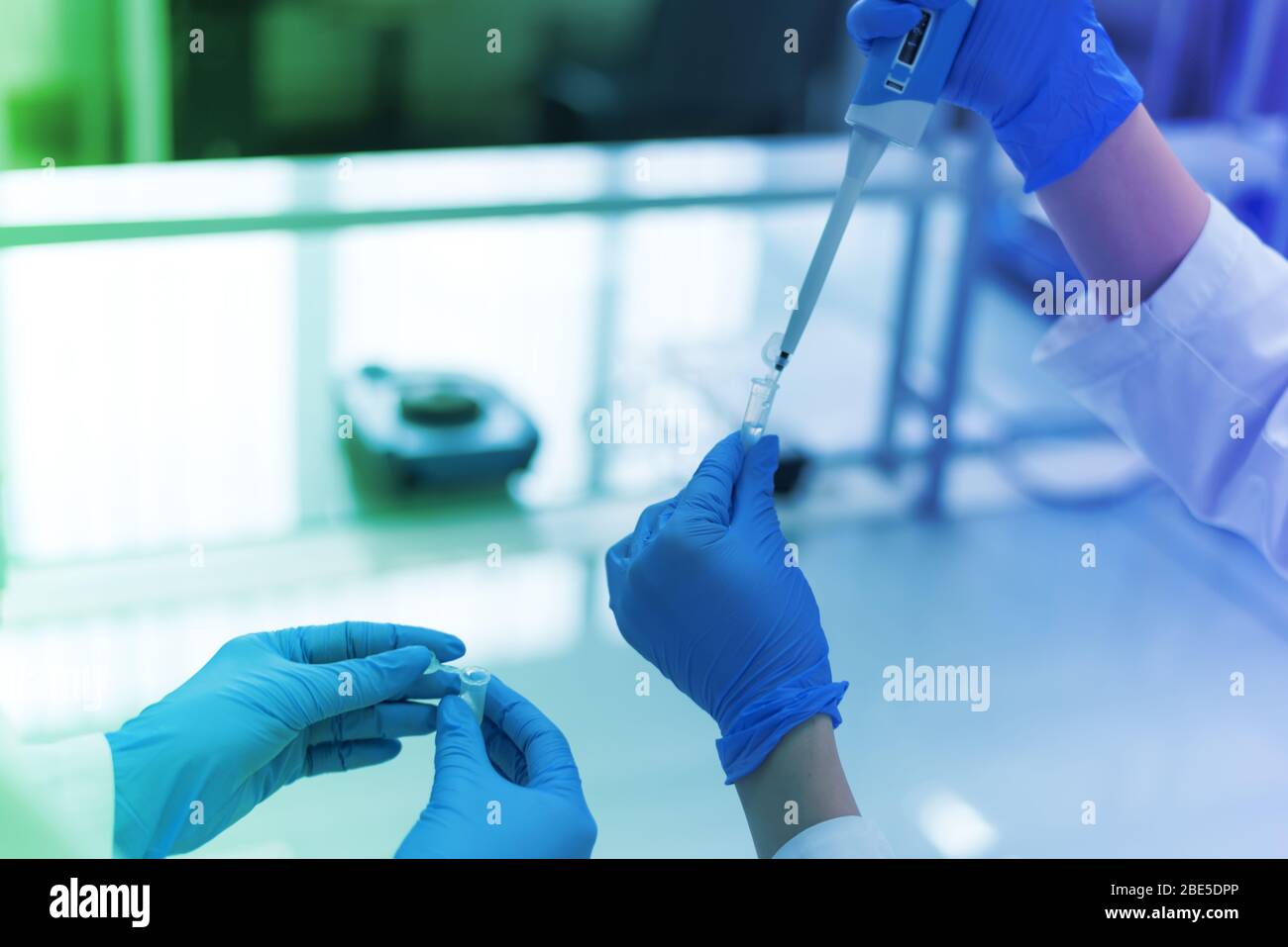 Group of Laboratory scientists working at lab with test tubes, test or ...