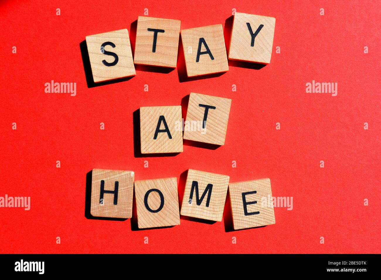 Stay Home, words in 3d wood alphabet letters on red background Stock ...