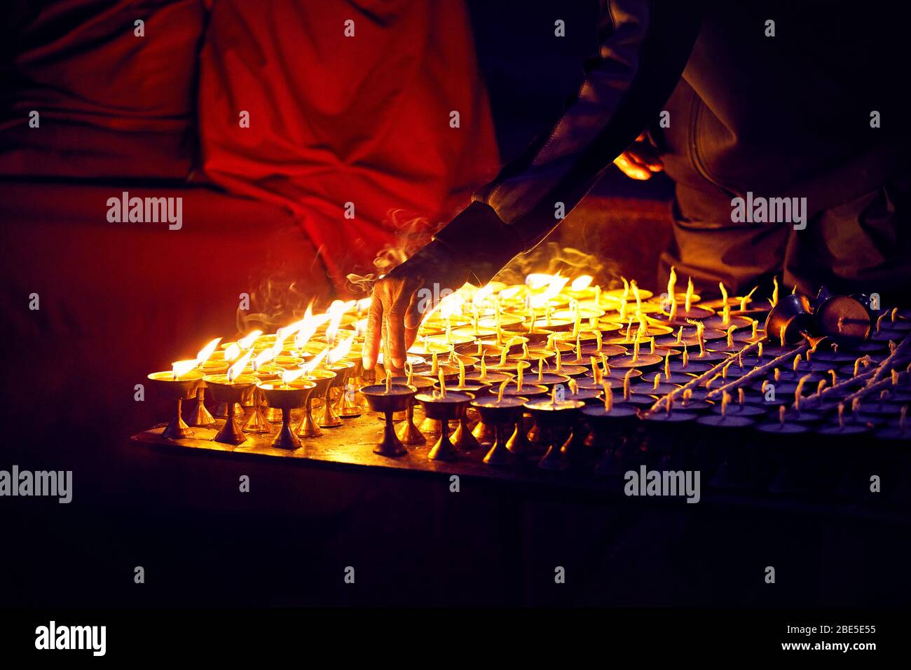 Monk fire the oil lamps of peace in the Buddhist Temple in Kathmandu ...