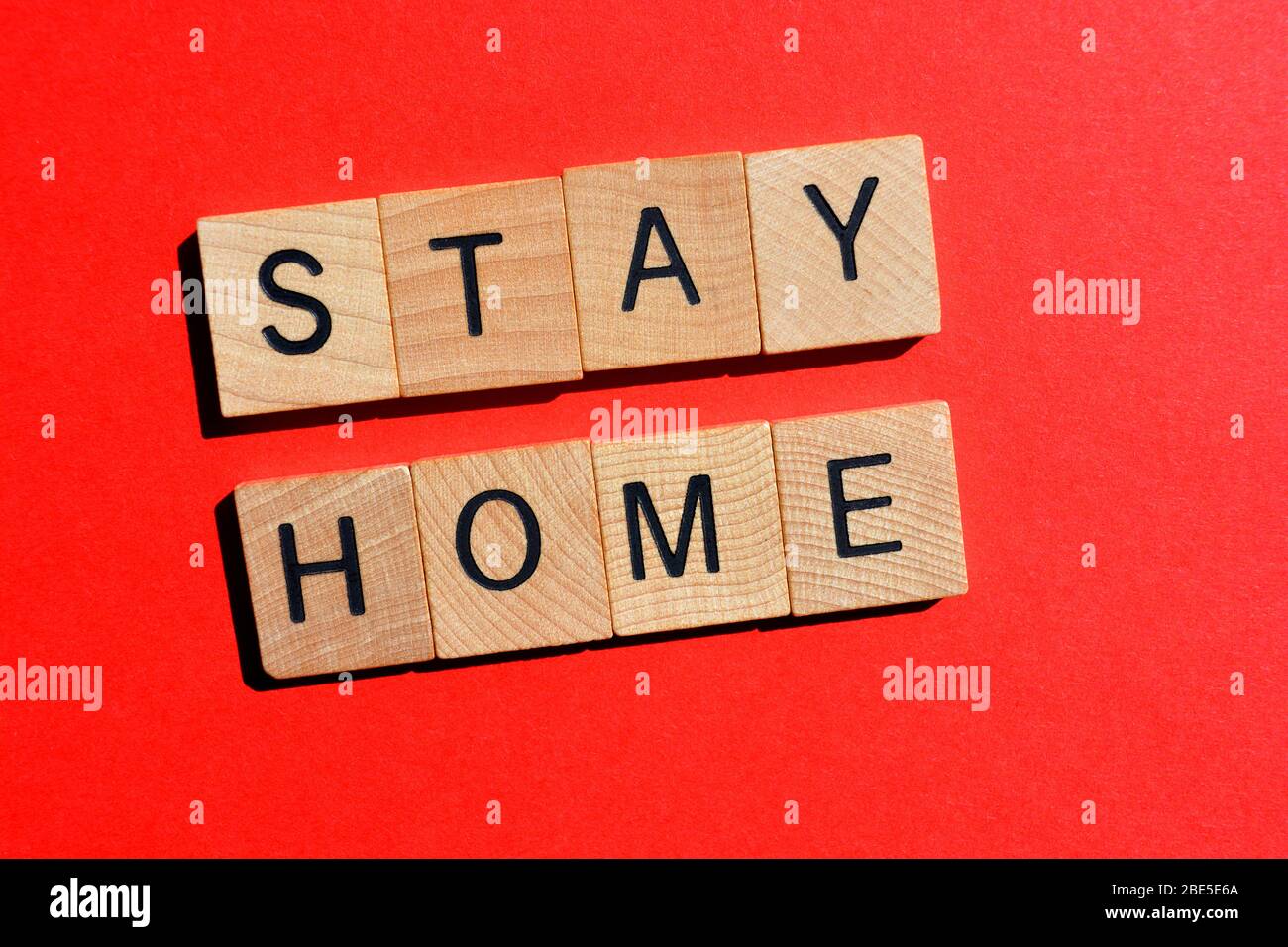 Stay Home, words in 3d wood alphabet letters on red background Stock ...