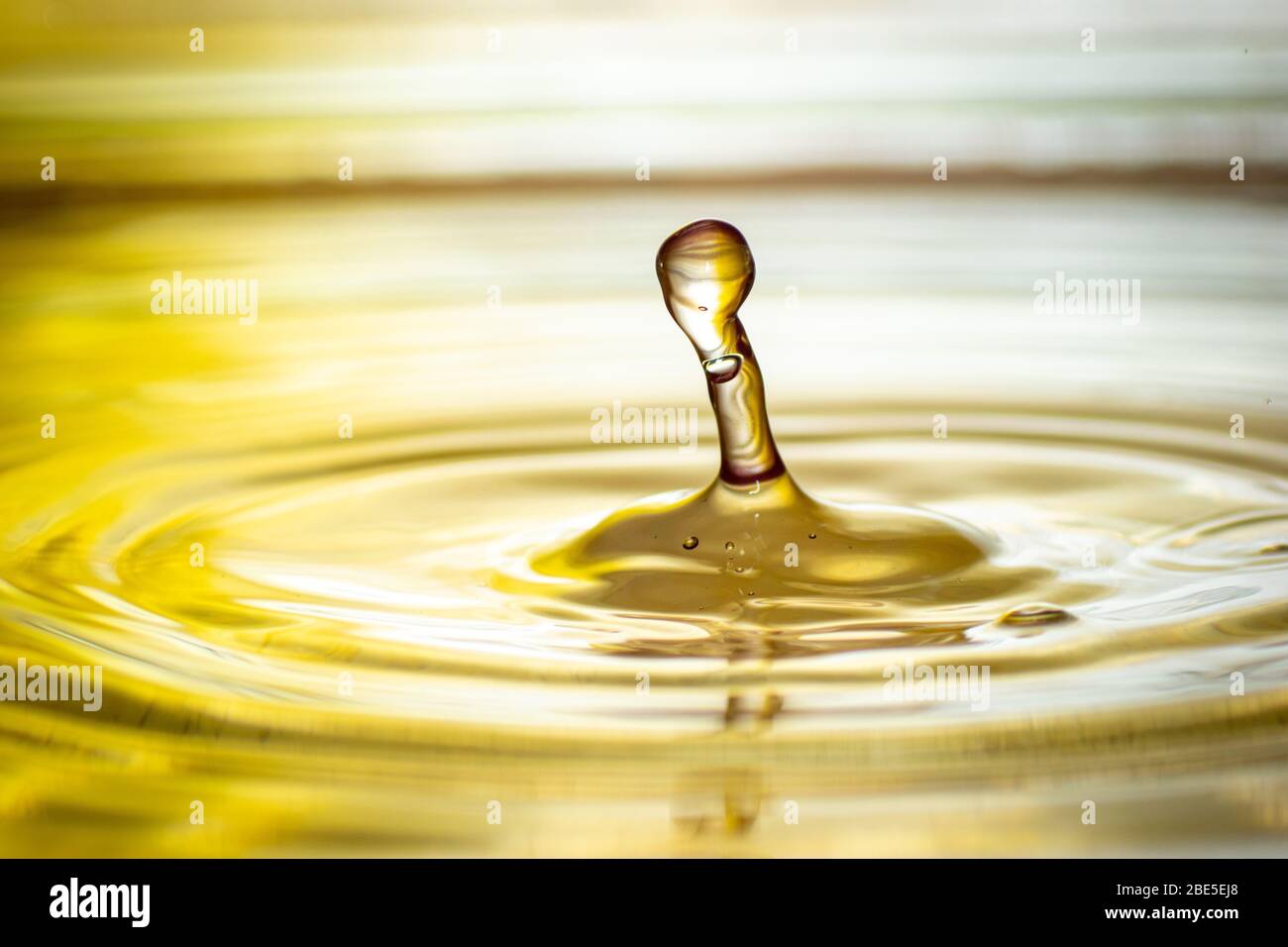 Yellow splash on water Stock Photo - Alamy