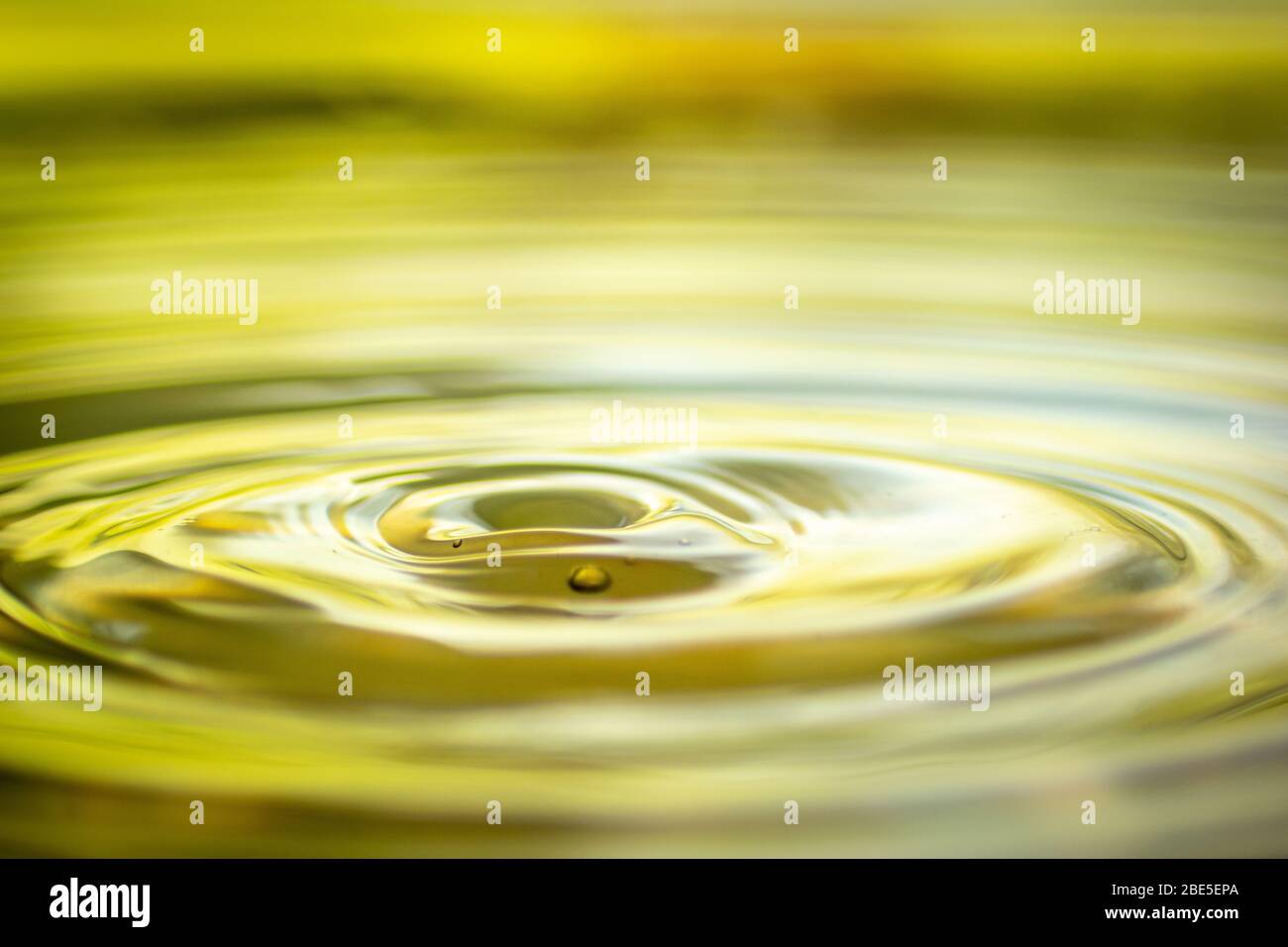 Yellow splash on water Stock Photo - Alamy