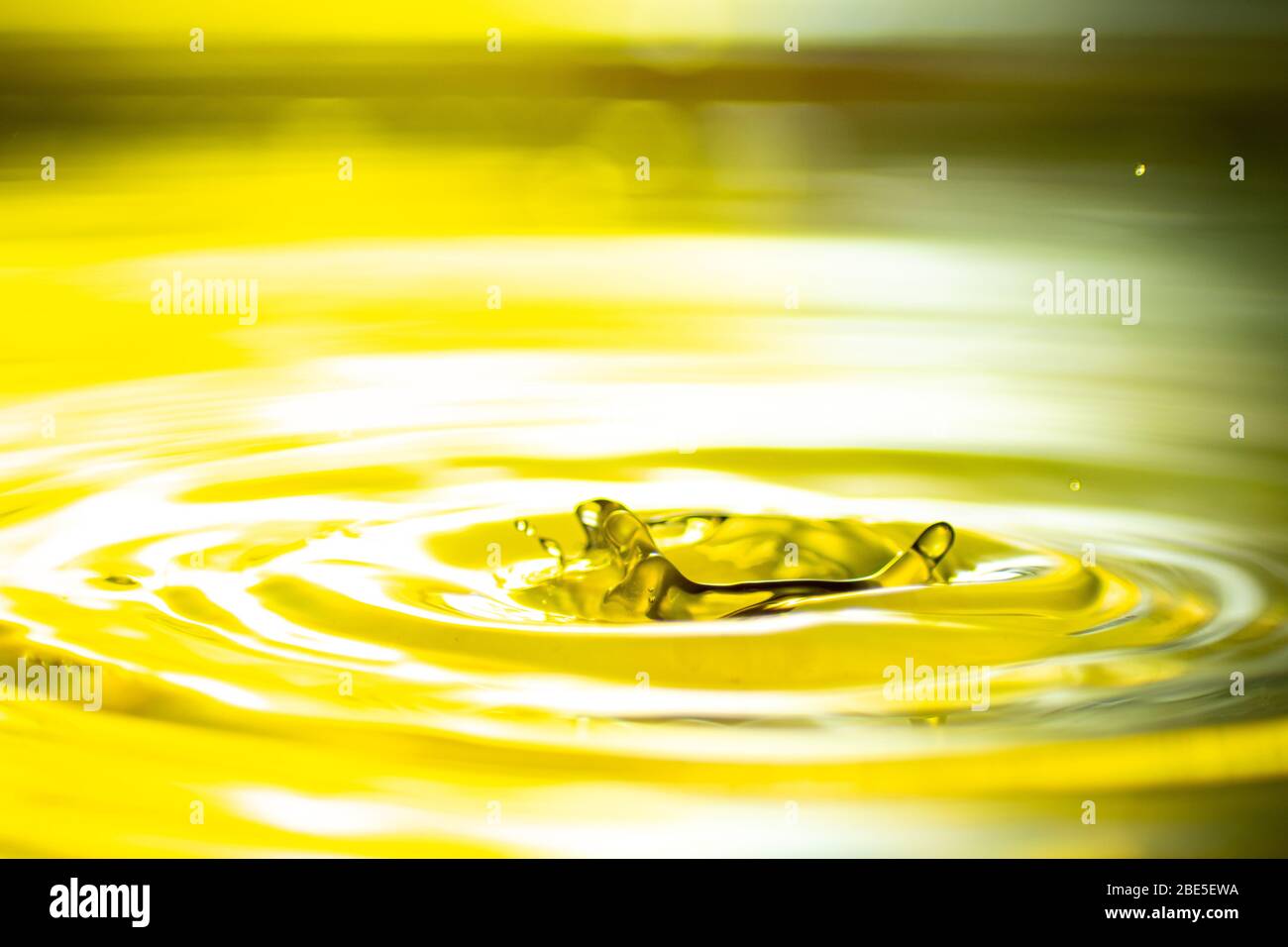 Yellow splash on water Stock Photo - Alamy