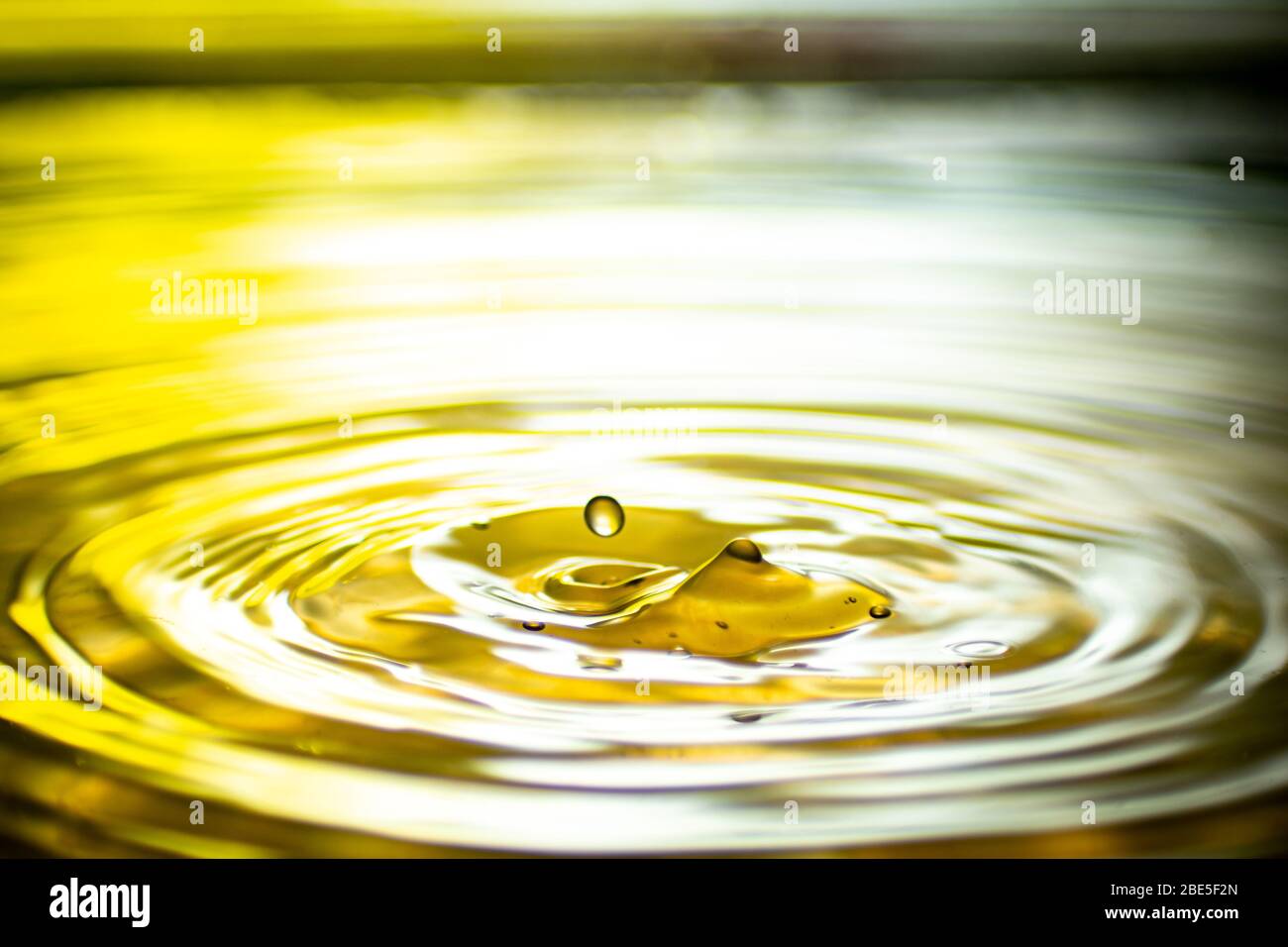 Yellow splash on water Stock Photo - Alamy